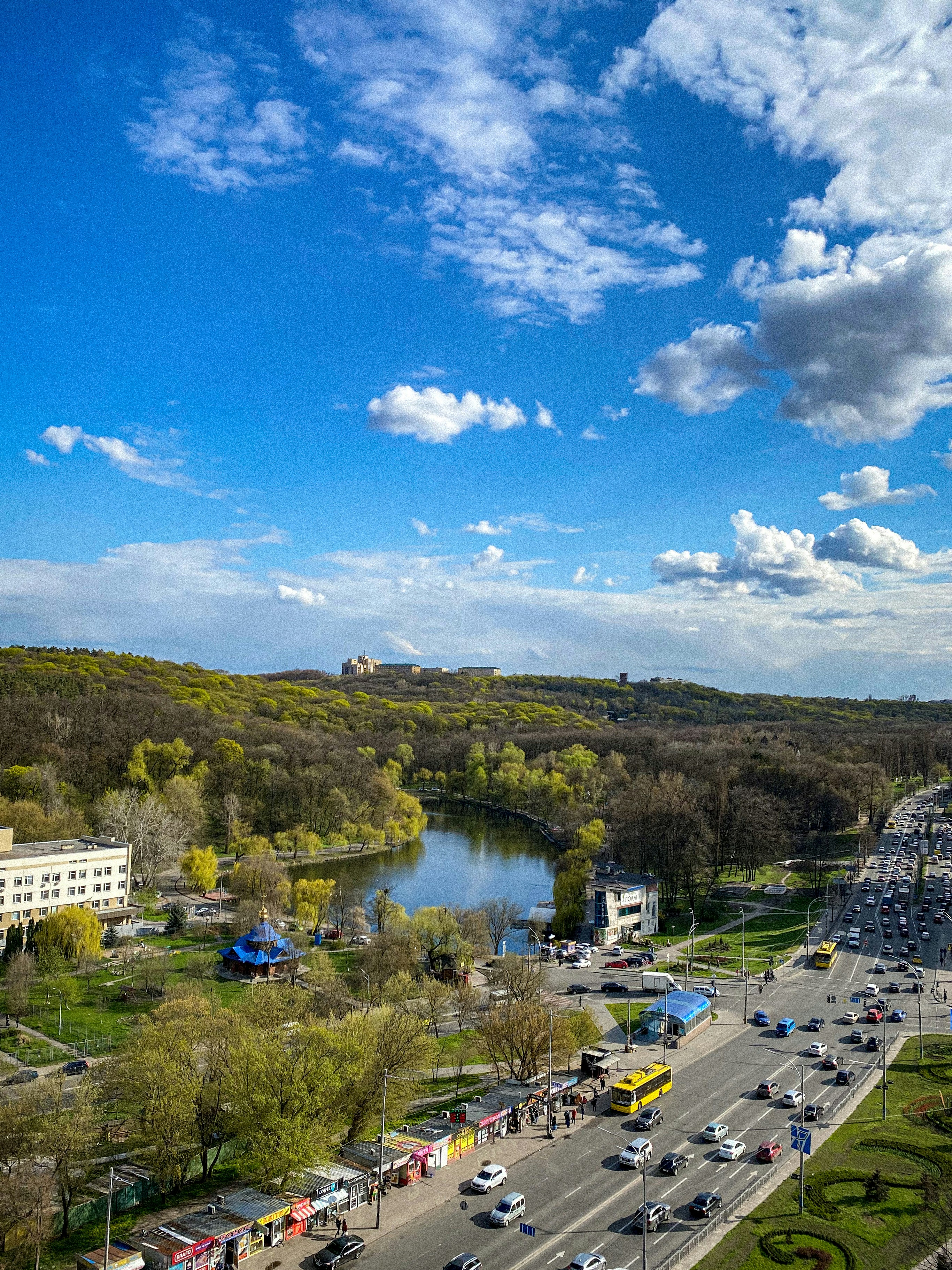 Urban Riverbend: Aerial View of a Busy City Park and Skyline