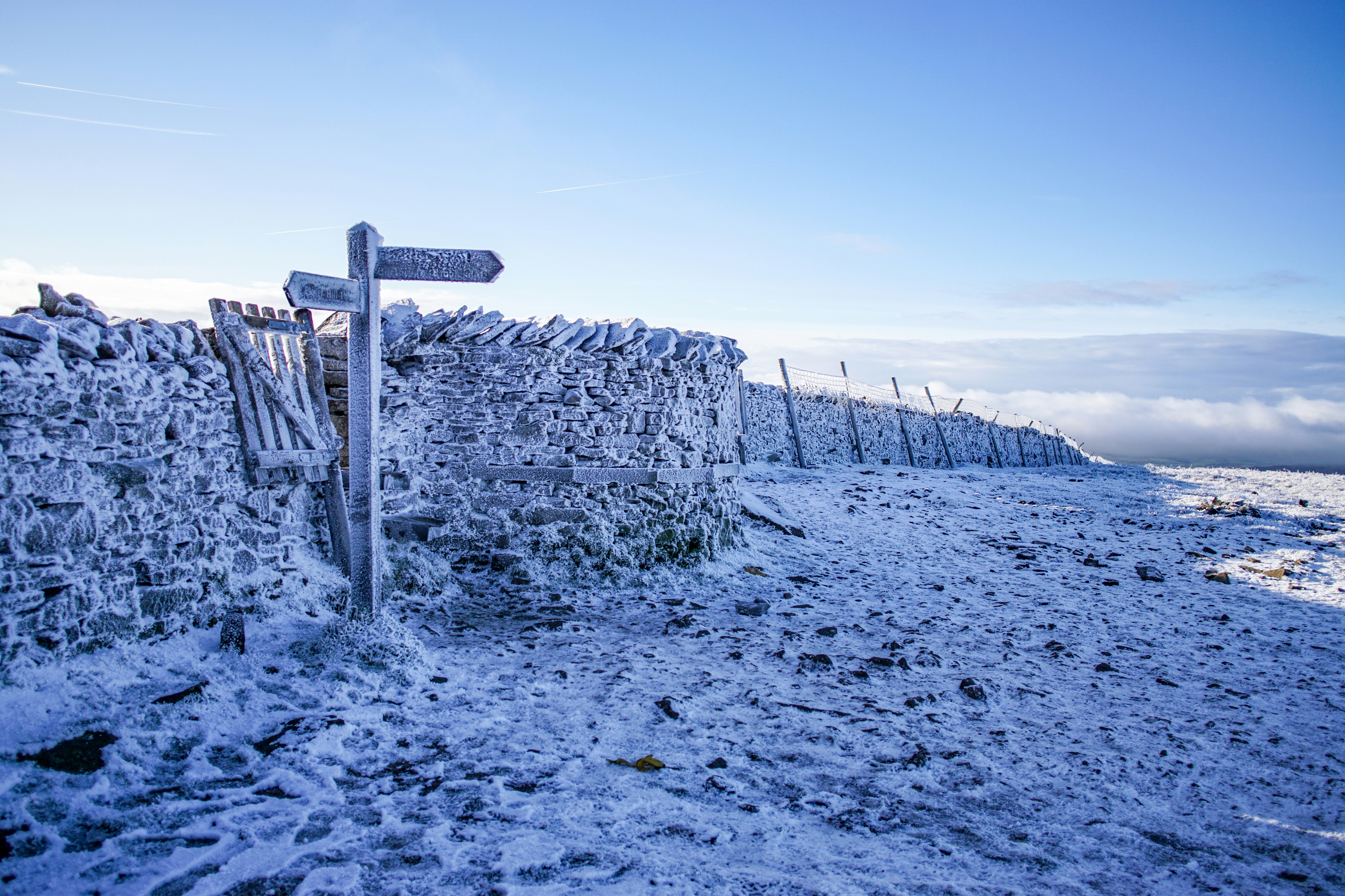 gray wooden fence on white sand during daytime