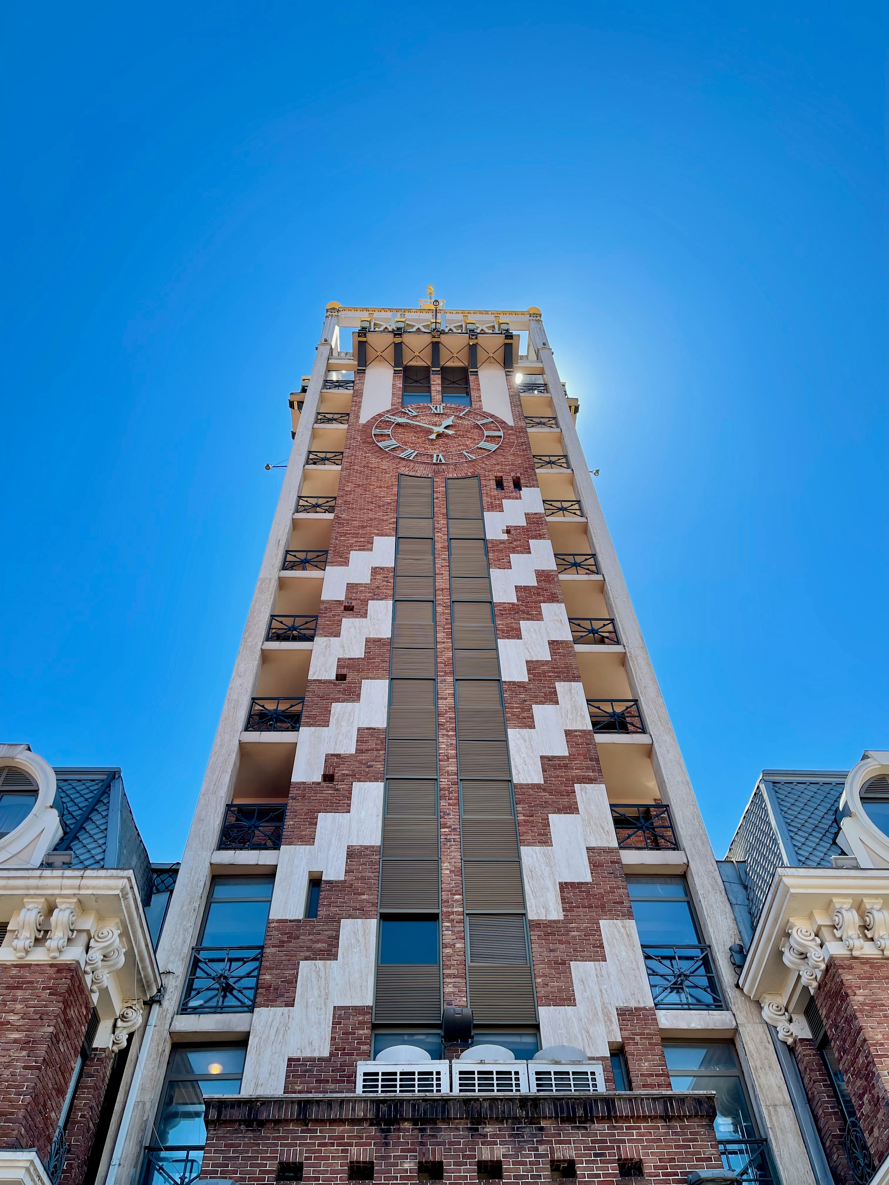 Apex of Brick and Sky: Clocktower Reaches Toward the Blue