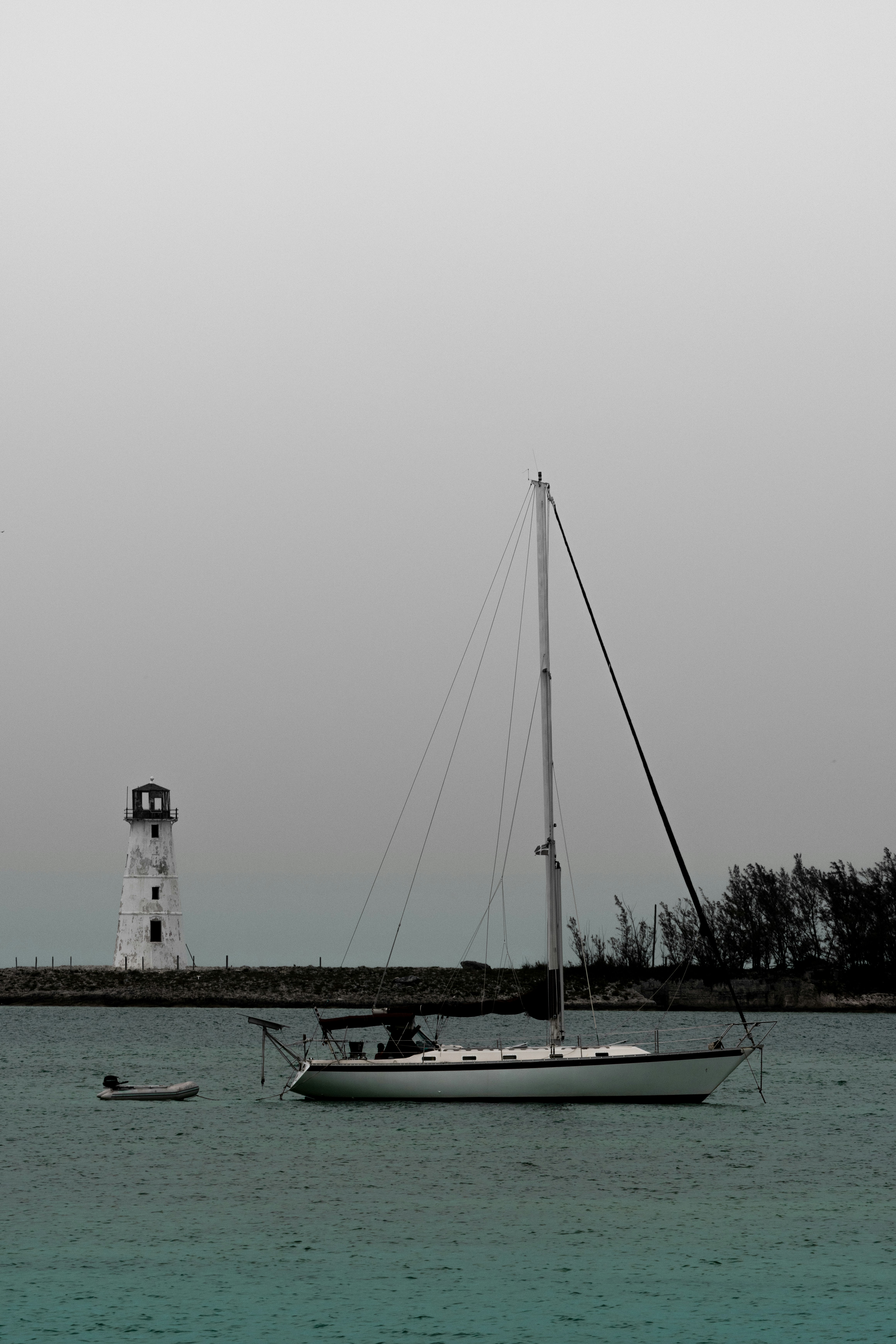 white and blue boat on sea during daytime