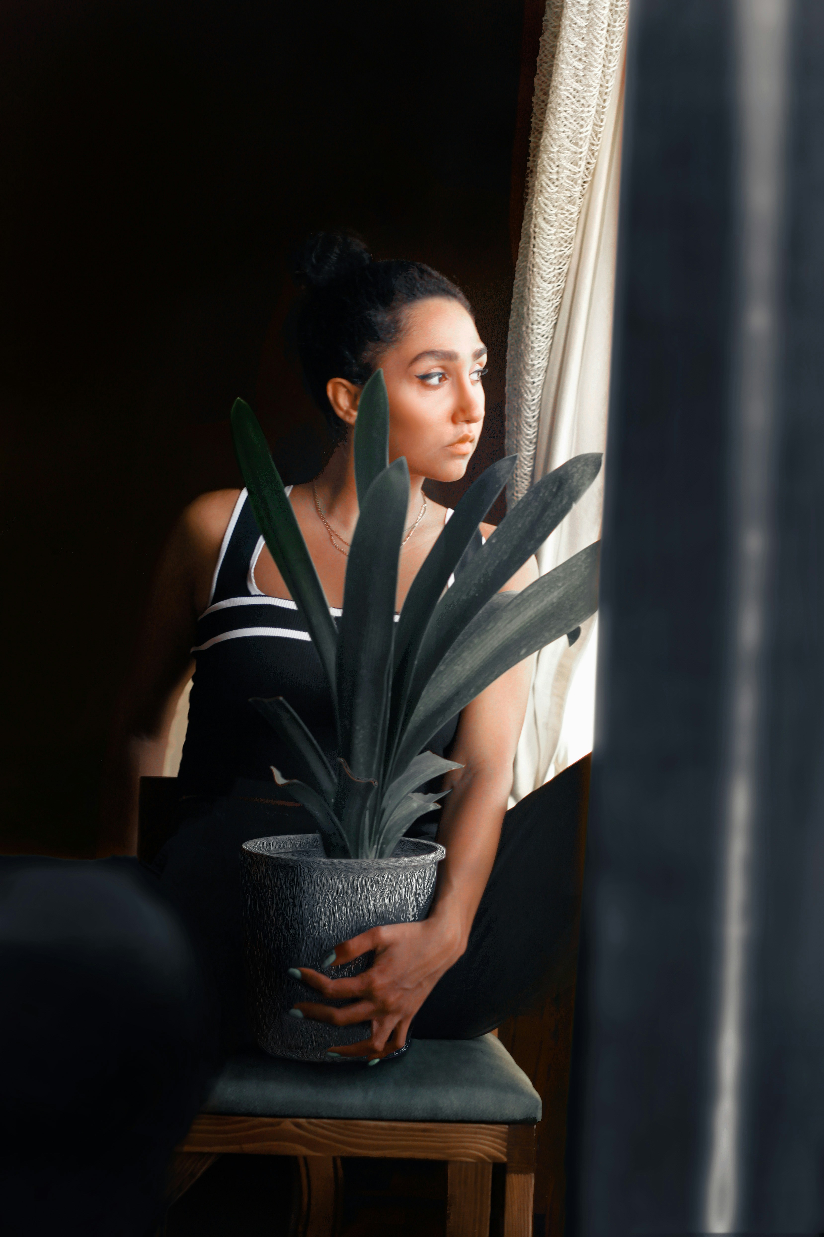 Portrait by the Window: Contemplation with a Potted Plant
