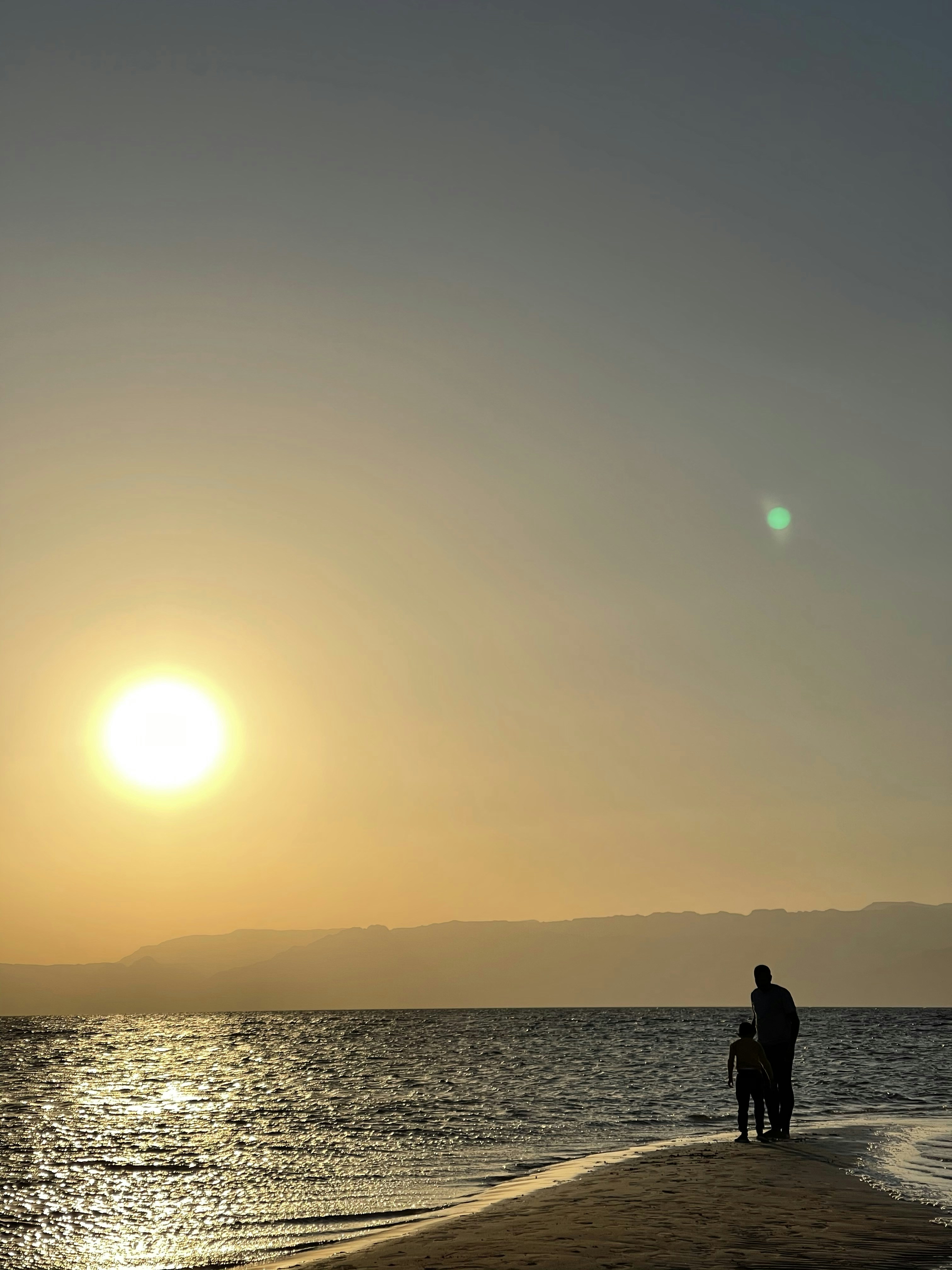 Silhouette of man and woman standing on seashore during sunset photo ...