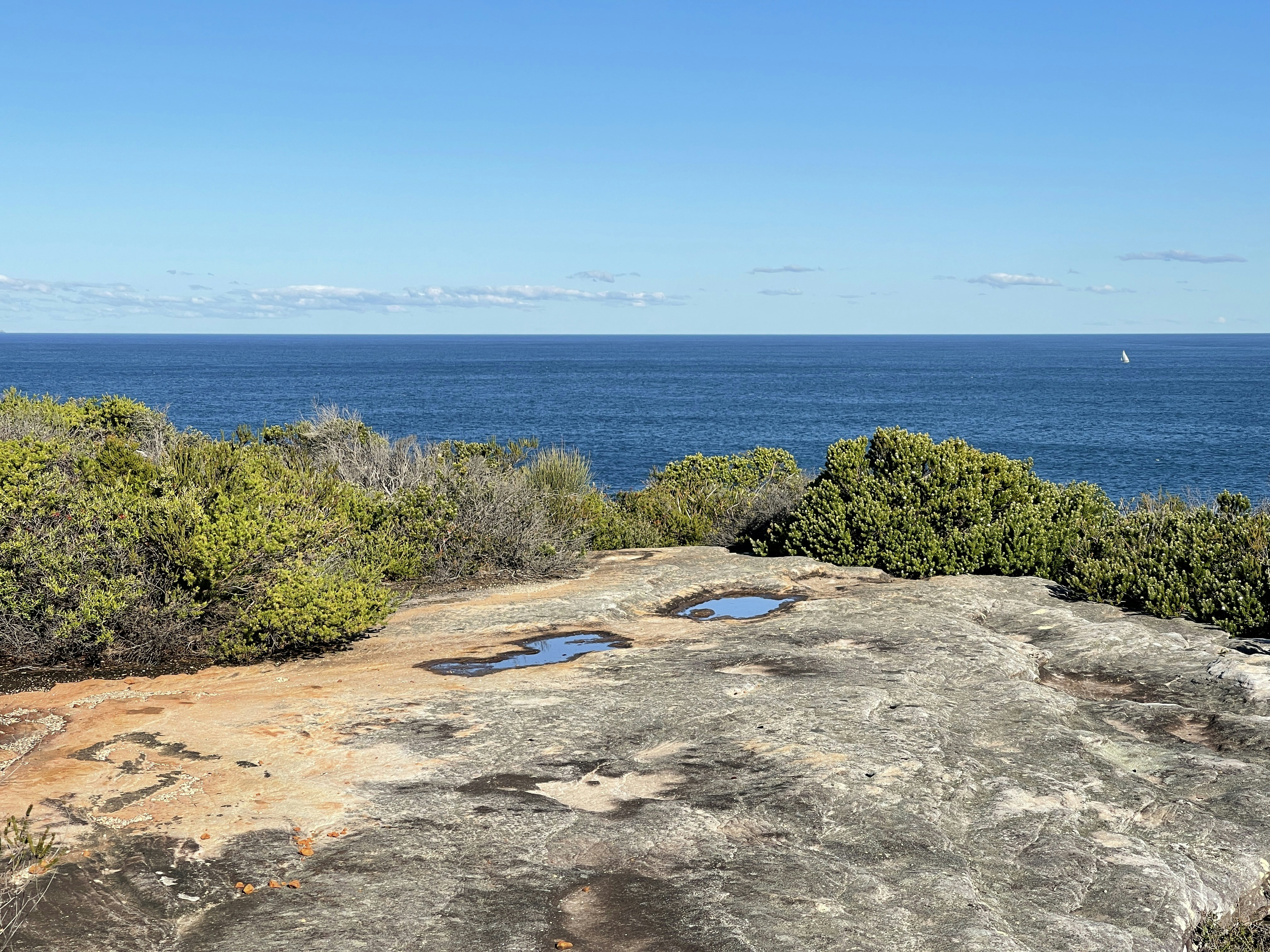 Coastal Tread: Sunlit Granite Overlooking a Quiet Ocean