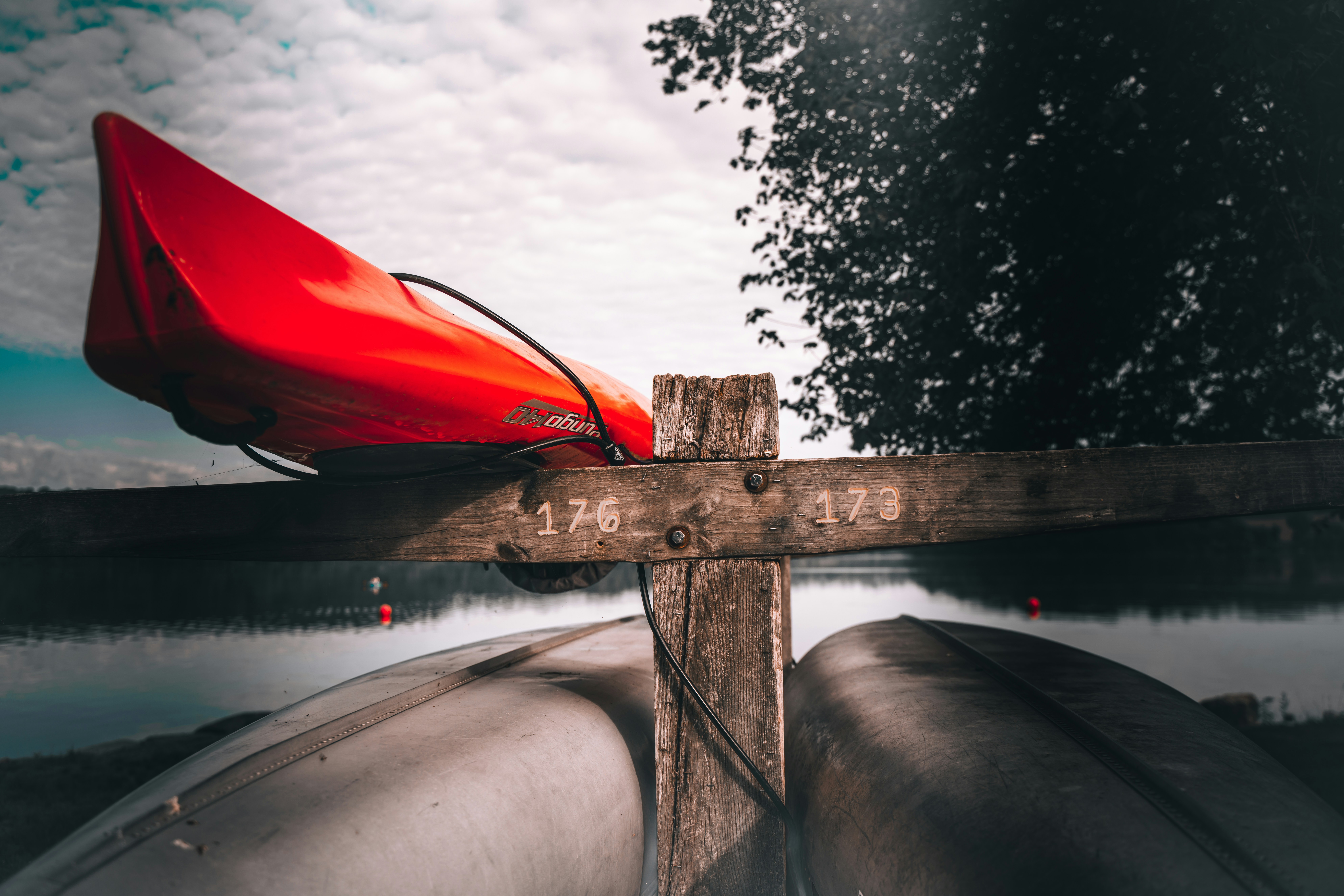 Red Kayak Resting Across Weathered Docks at a Quiet Marina