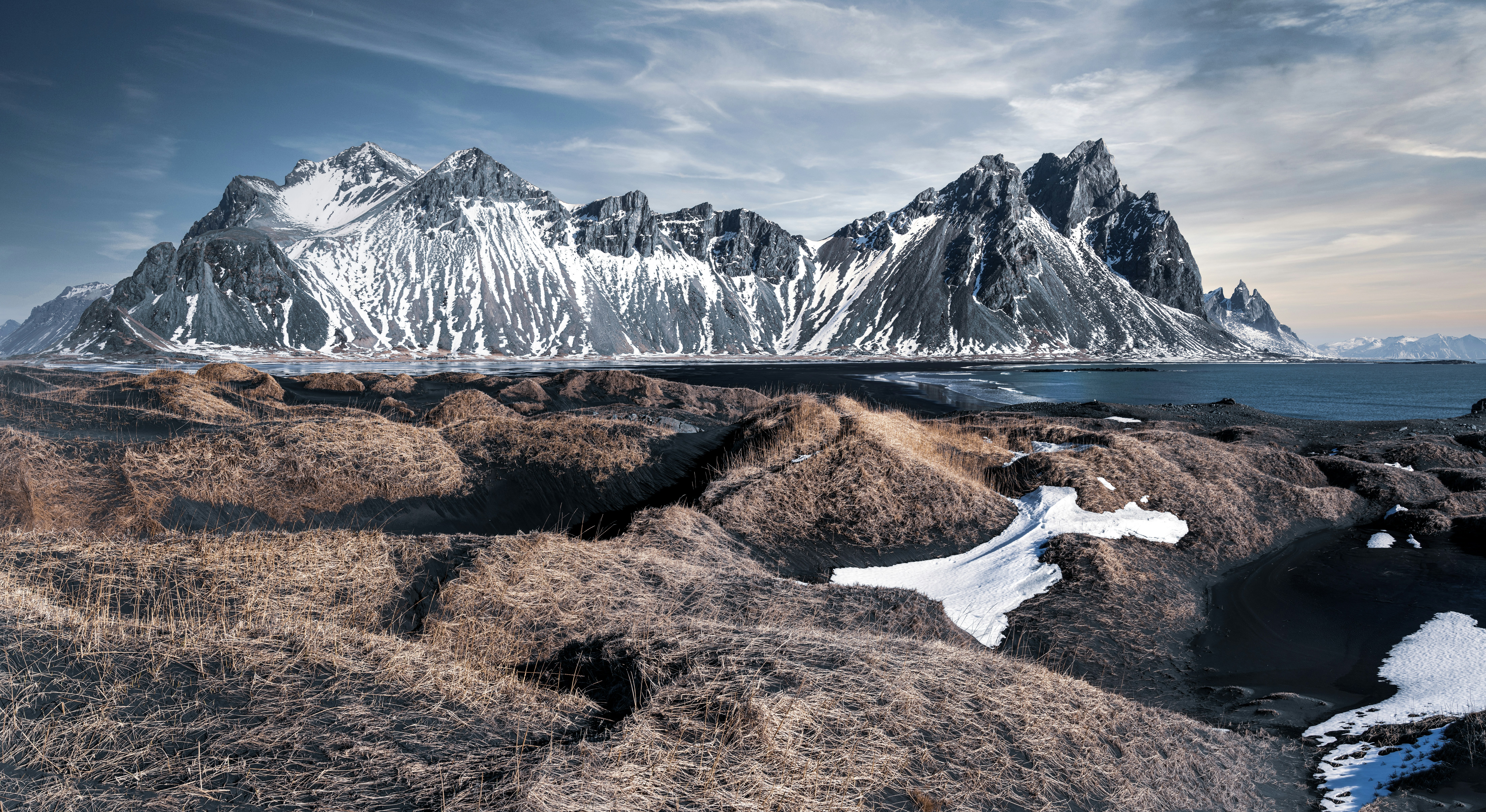 Stokksnes | brown and white mountains under white clouds during daytime