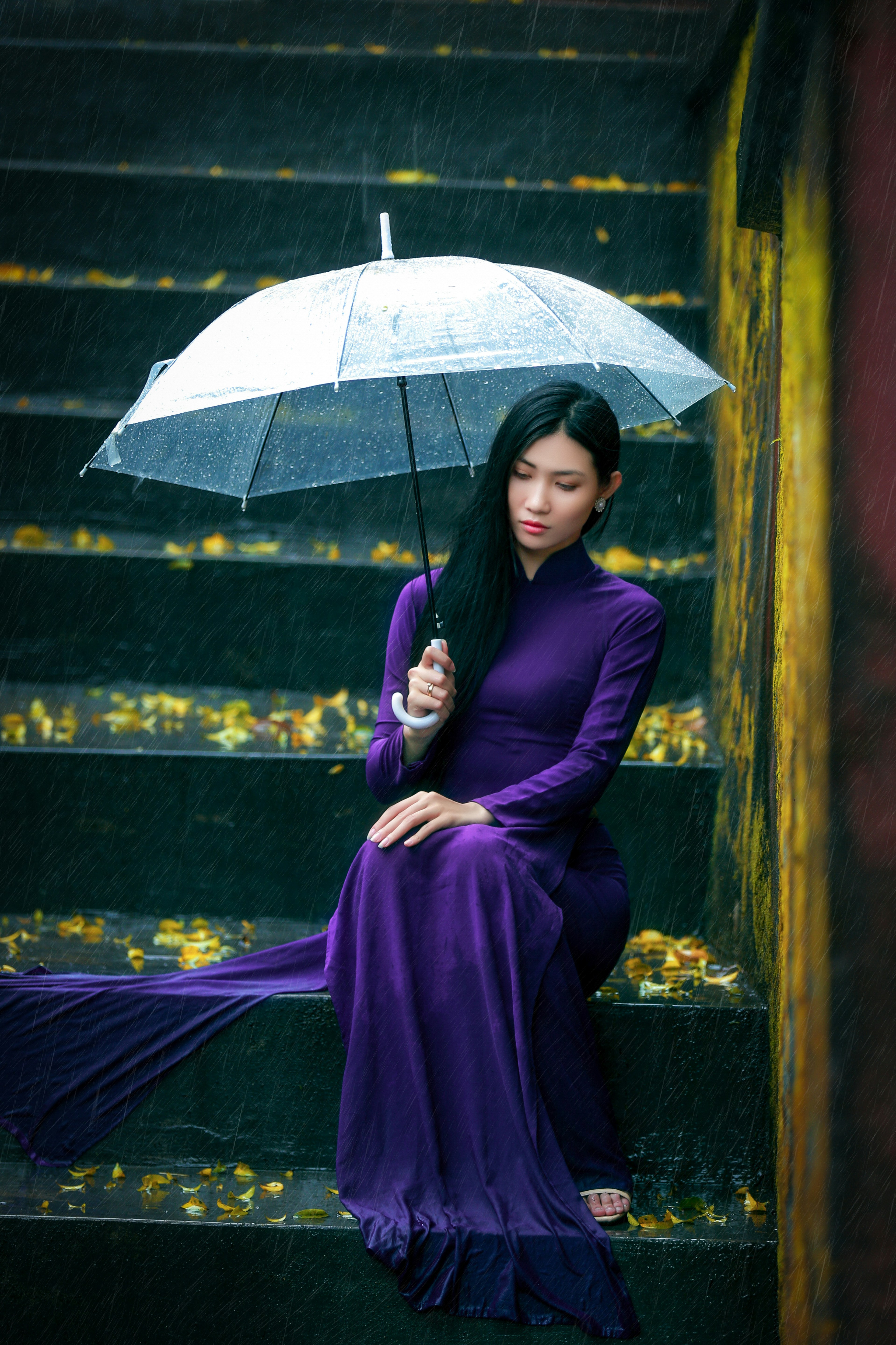 Purple silence: a woman in a violet cheongsam beneath rain with a white umbrella on stone steps