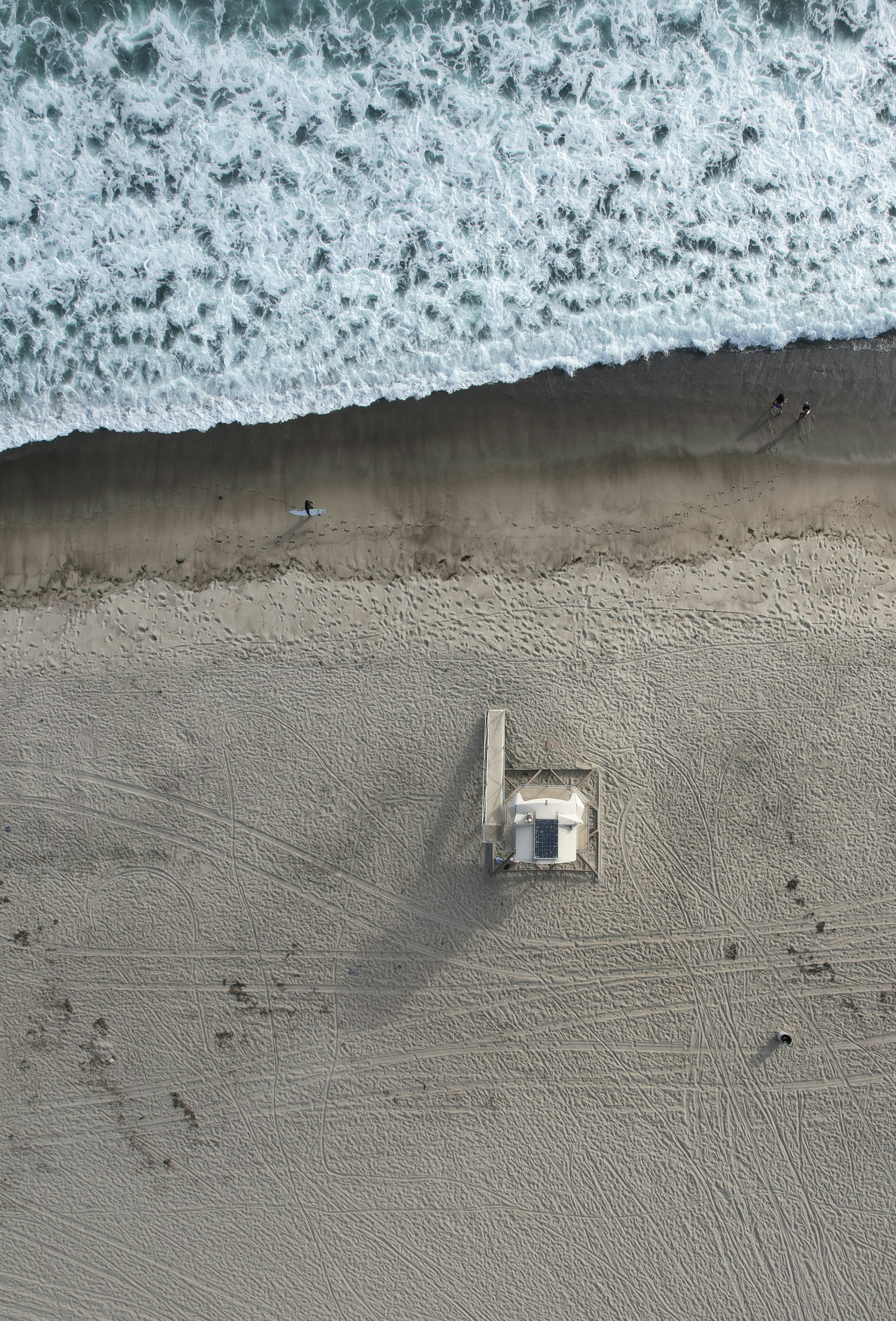 white and brown wooden house on beach shore during daytime