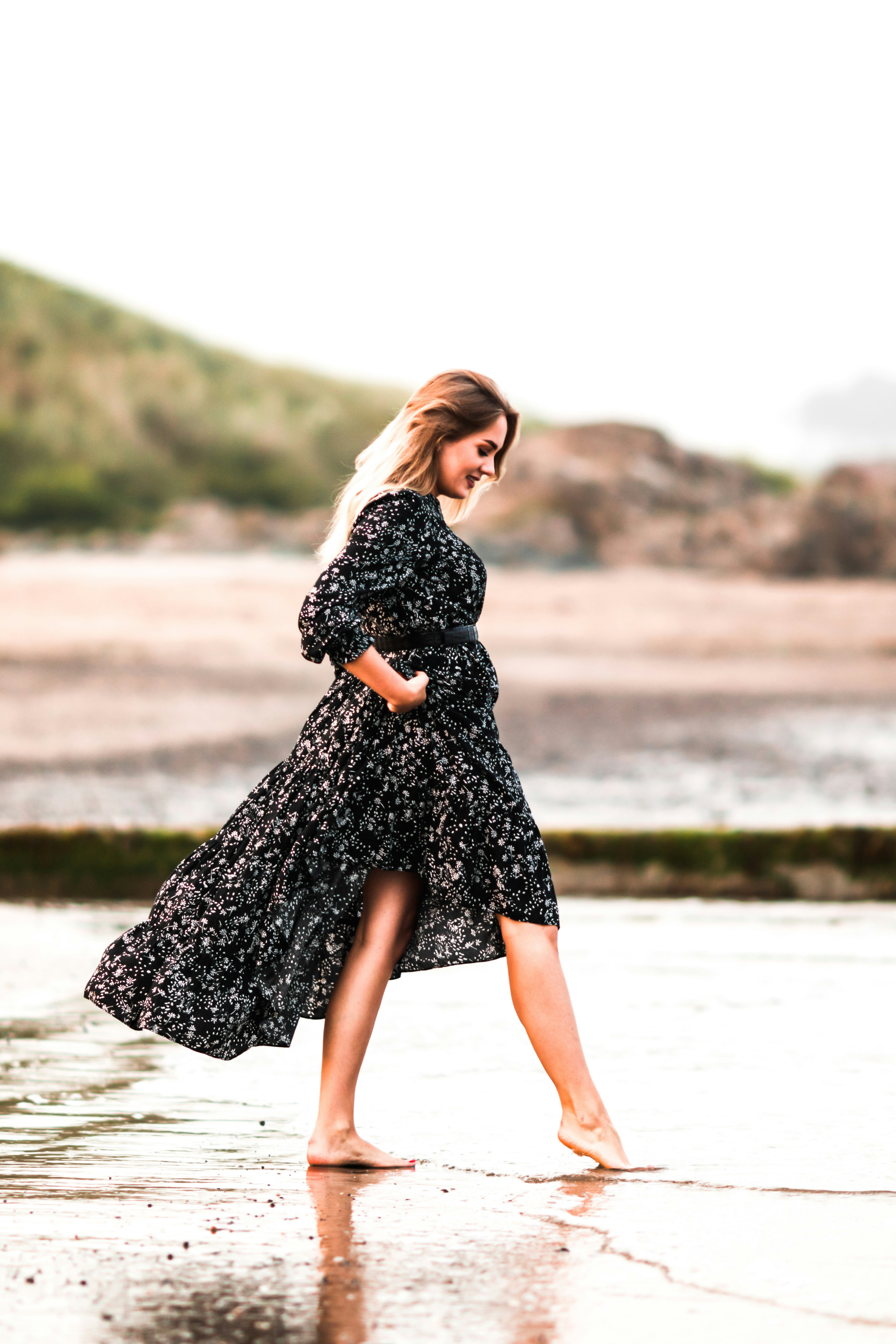 Floral Gown on Wet Sand: A Quiet Beach Maternity Moment