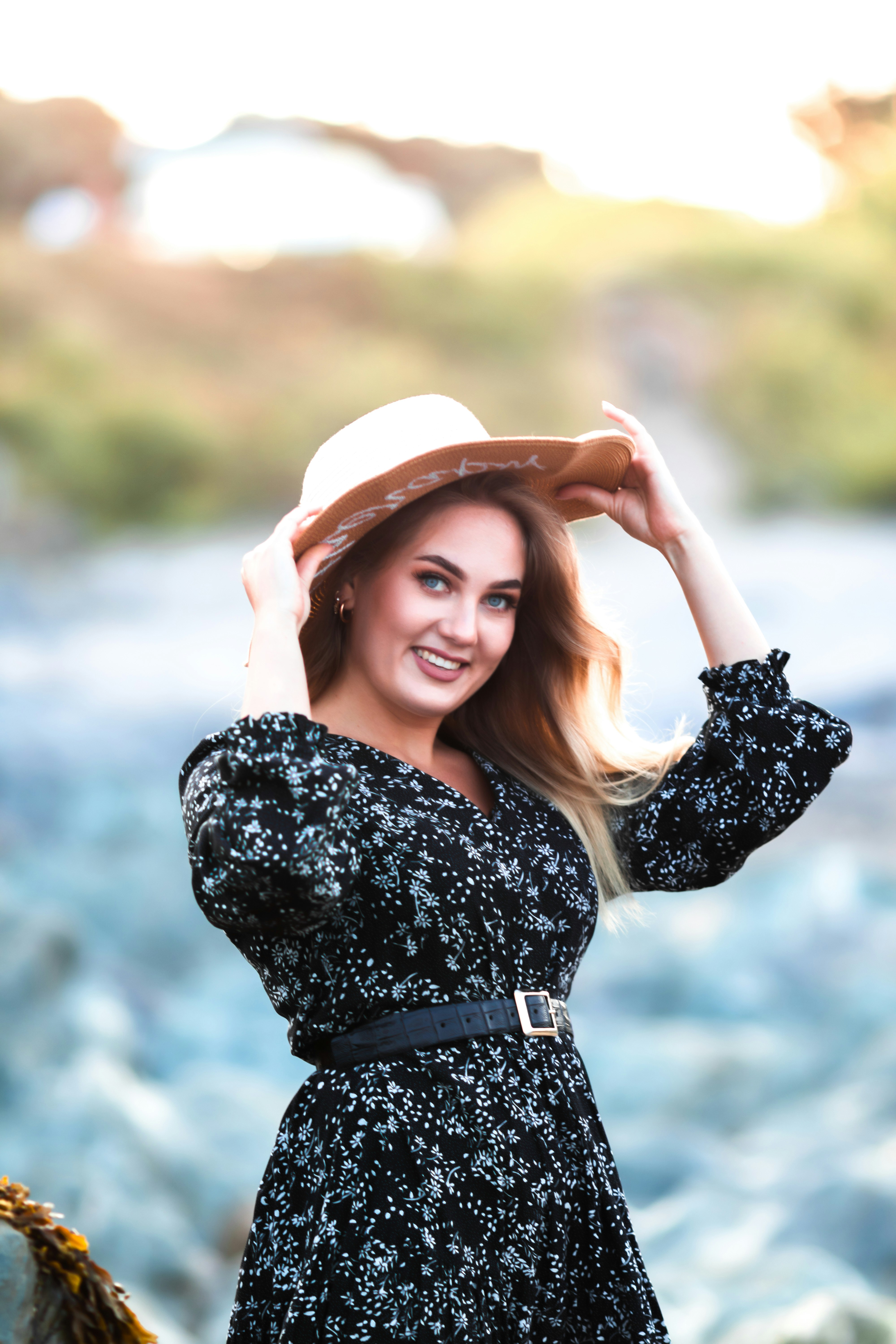 Sunlit Smile by the Seashore: A Portrait with Creamy Bokeh