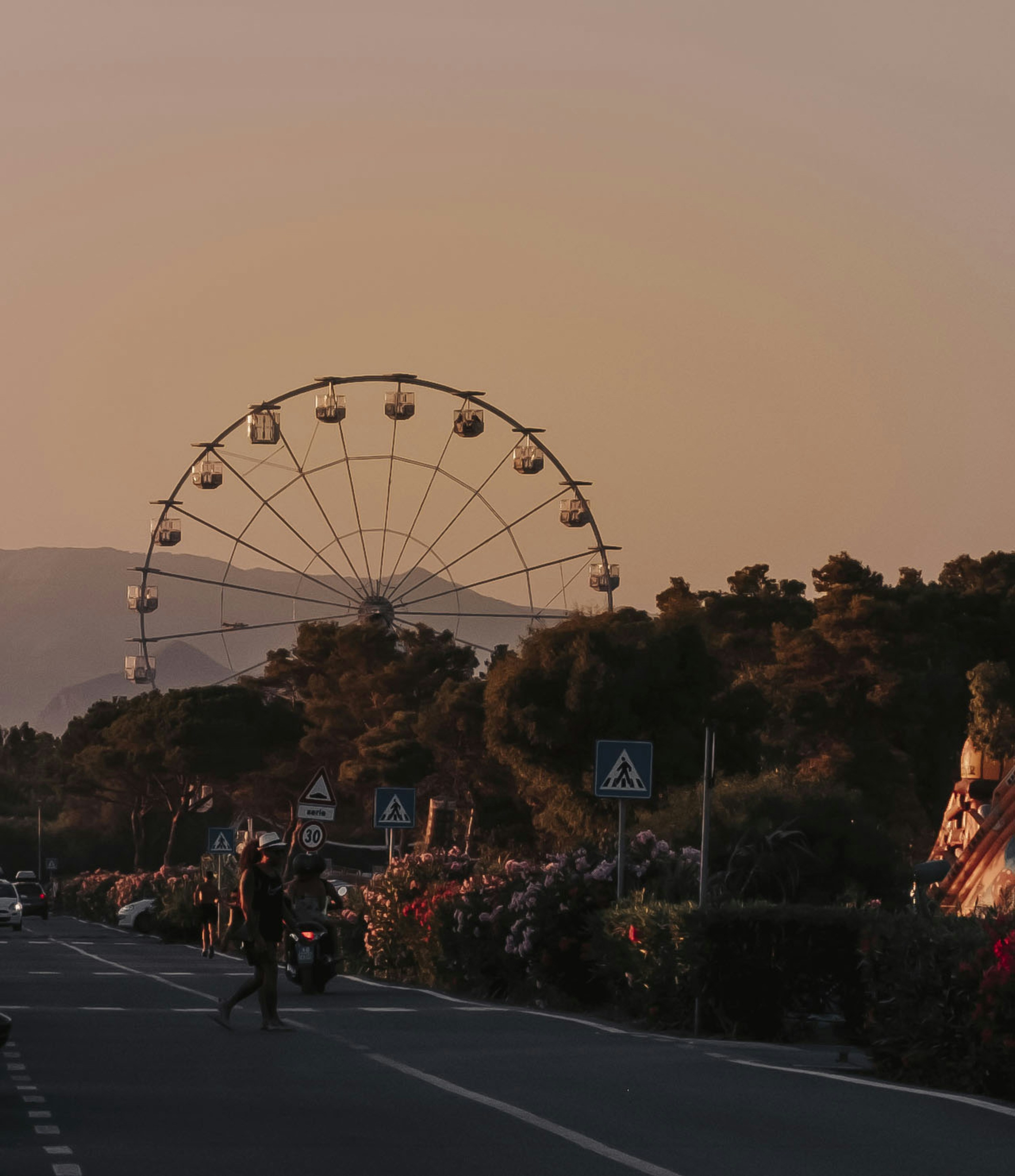People walking on park with ferris wheel in the distance photo – Free ...