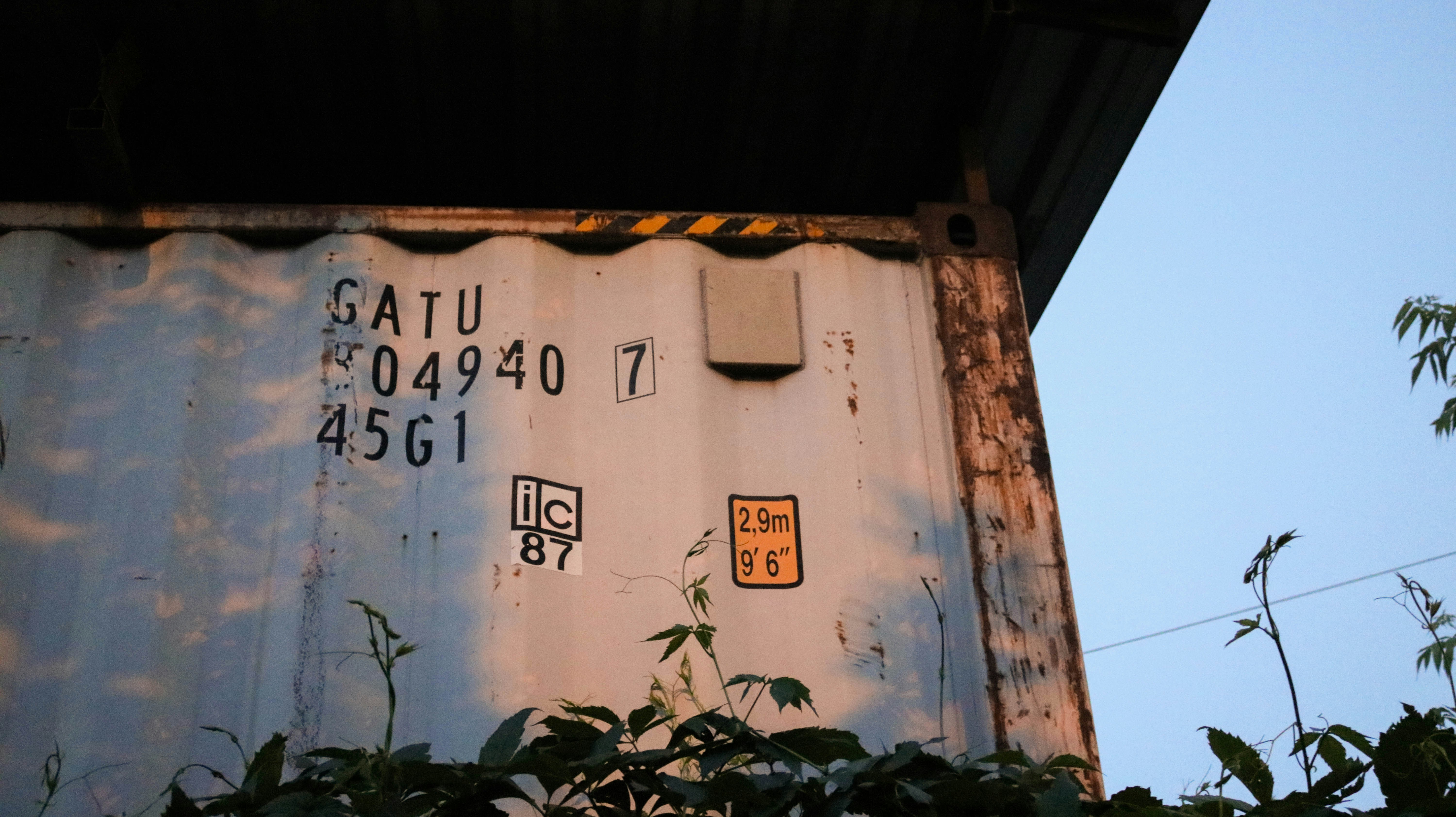 Orange Datum on a Weathered Blue Freight Container