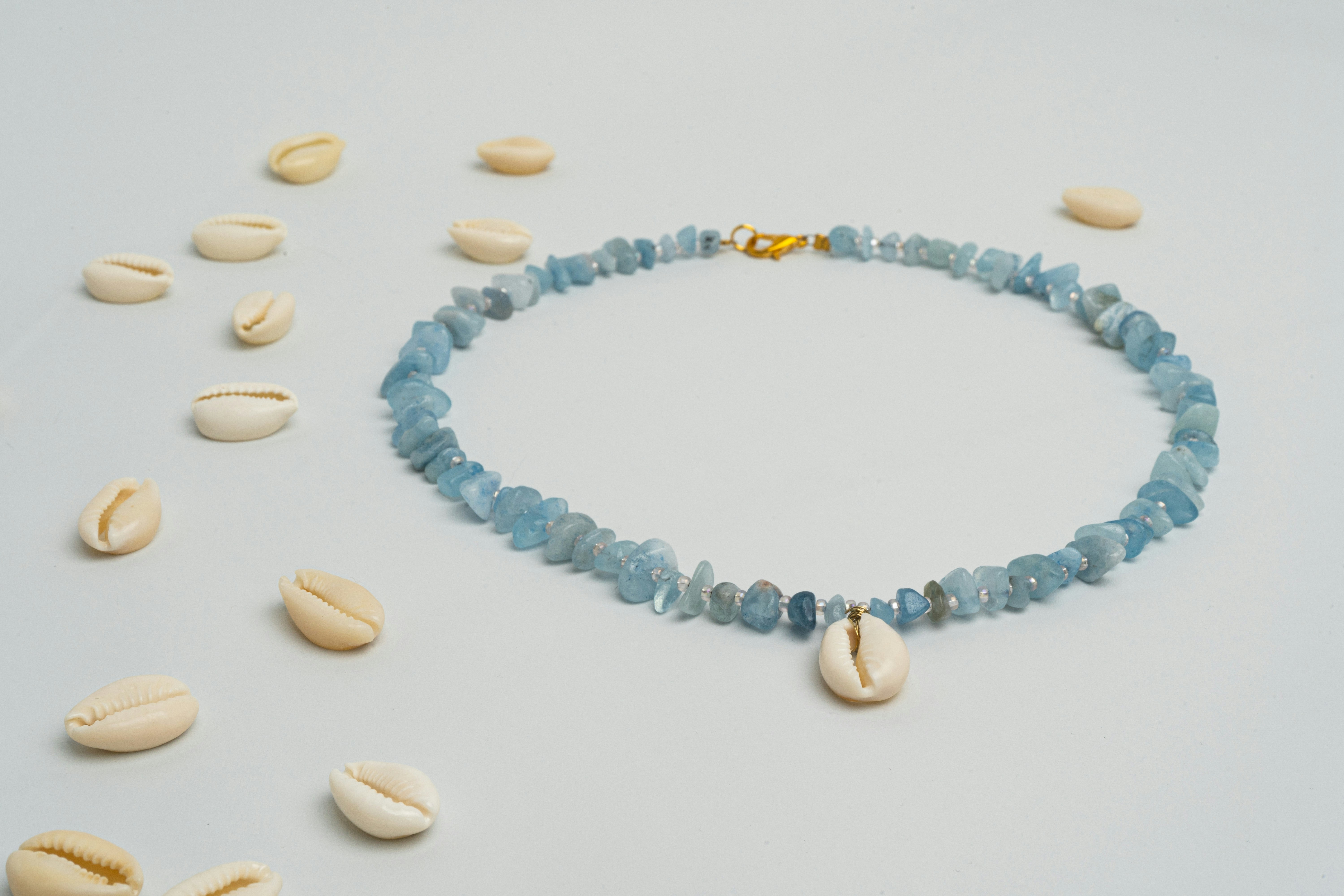 Aquamarine Bead Bracelet on a Minimal Seashell Stage