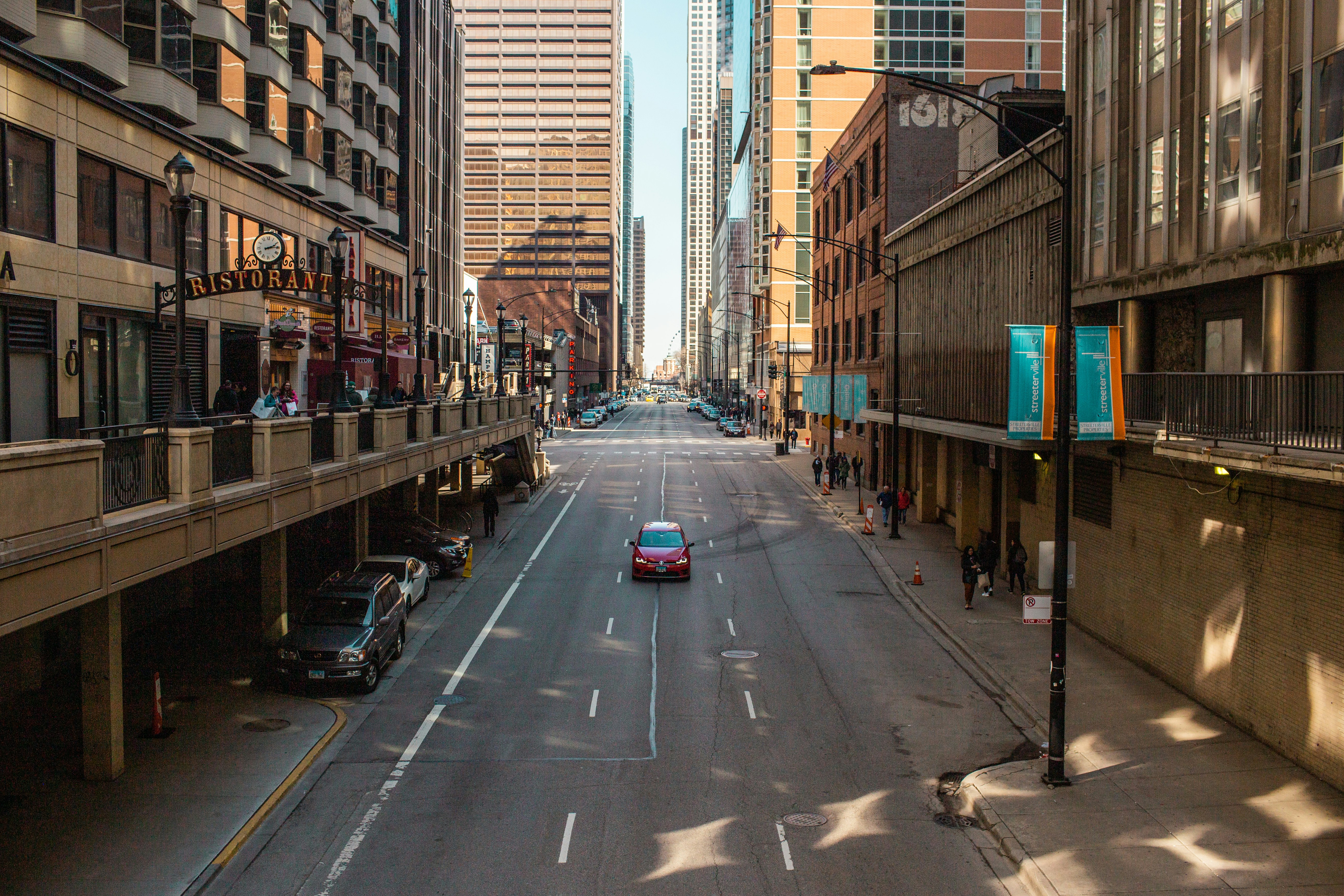 Cars on road between high rise buildings during daytime photo – Free ...