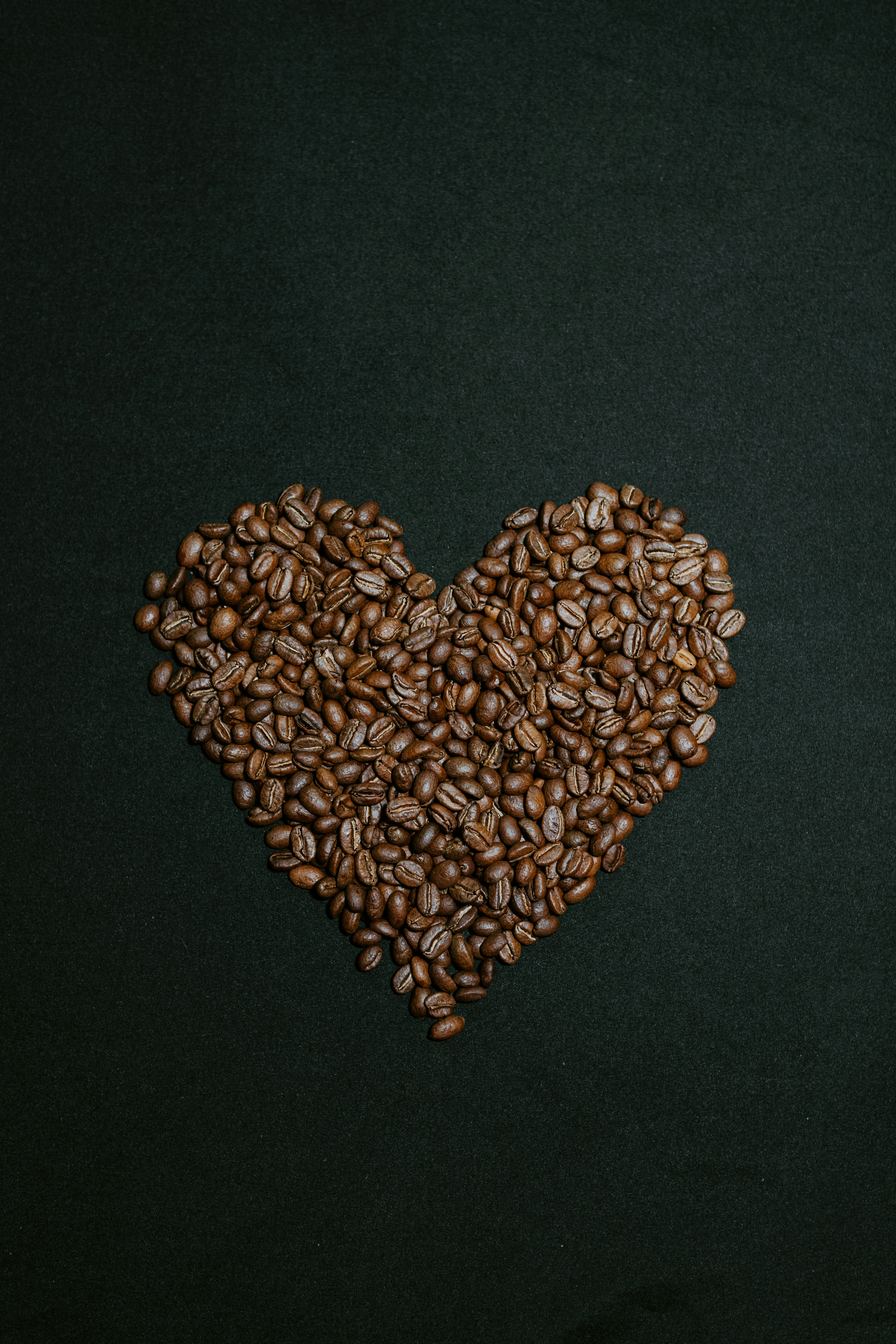 Heart of Roast: A heart-shaped mosaic of roasted coffee beans against a midnight canvas