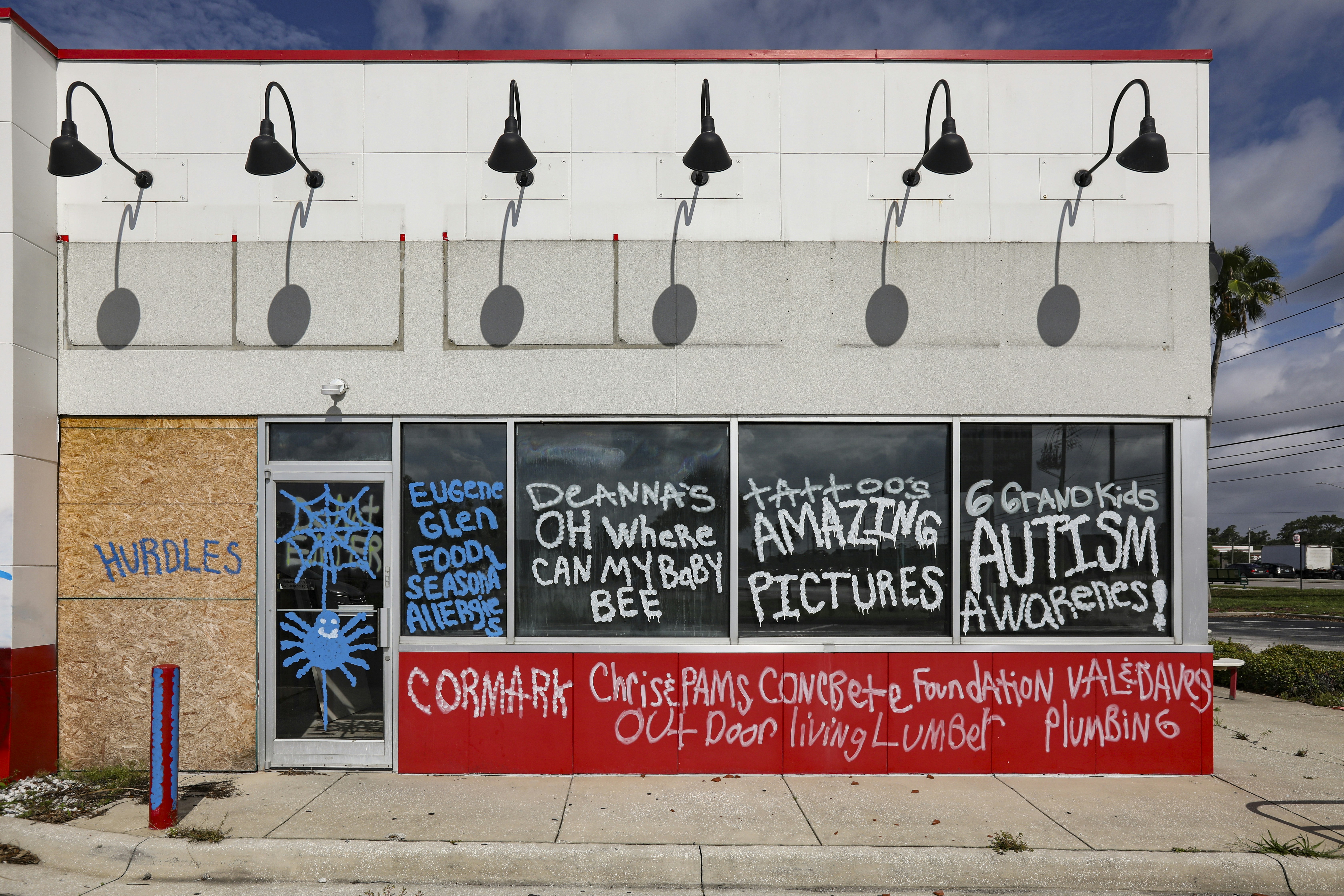 Graffitied Gallery: A Colorful Message Wall Under Round Lamps
