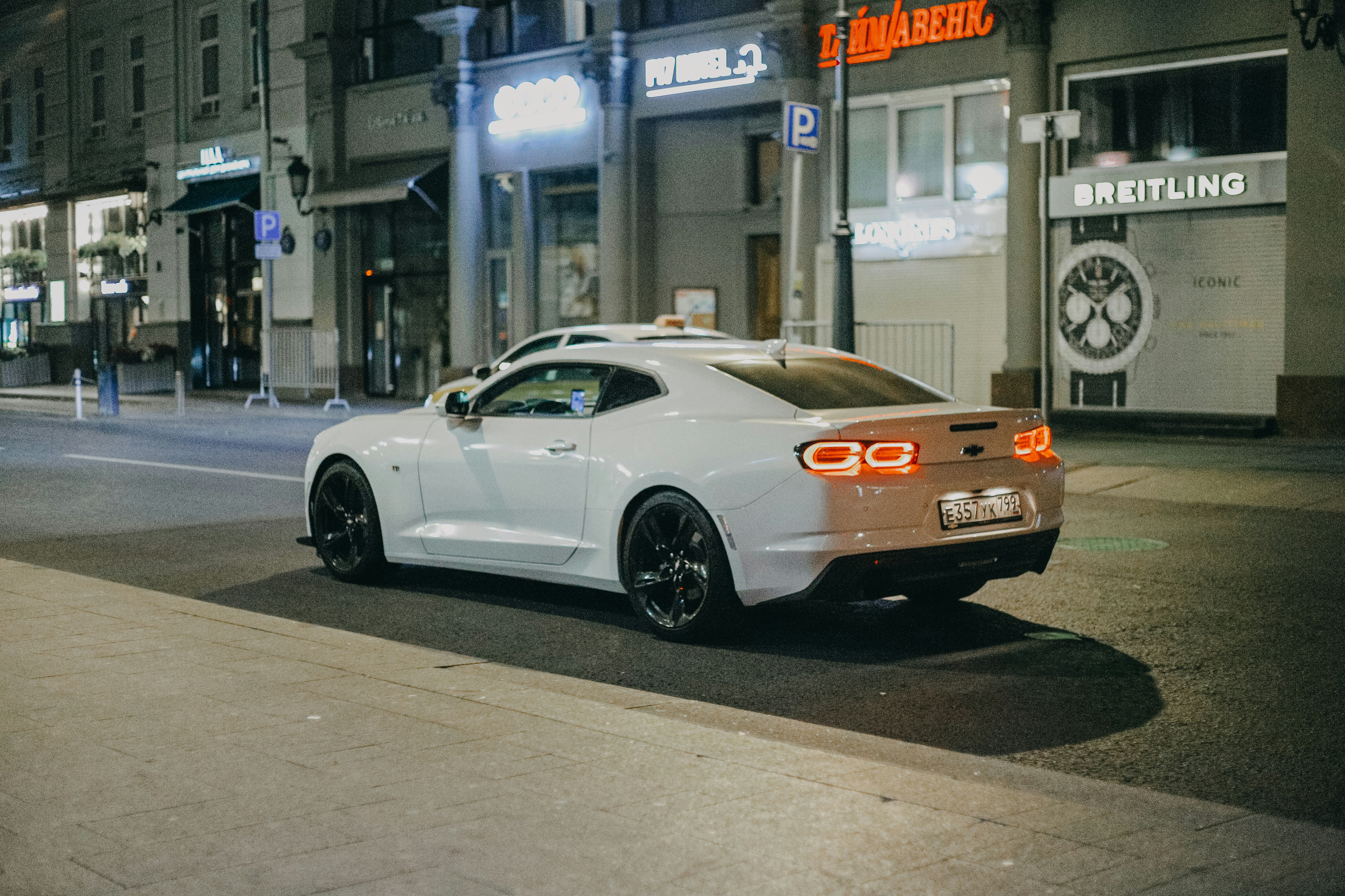 white porsche 911 parked on street during nighttime