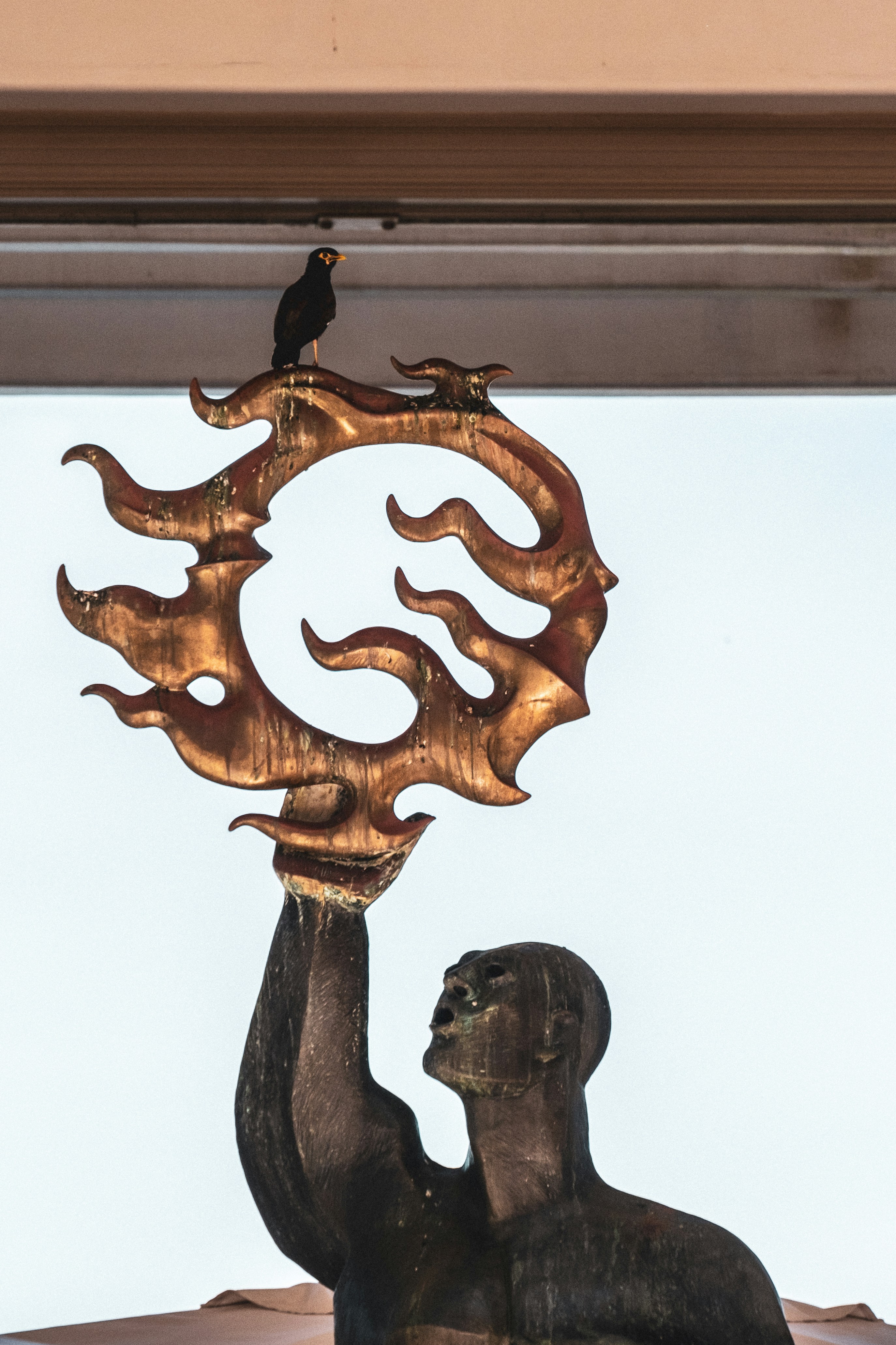 Burning Flame Stalwart: A Bronze Figure Reaching Toward the Sky