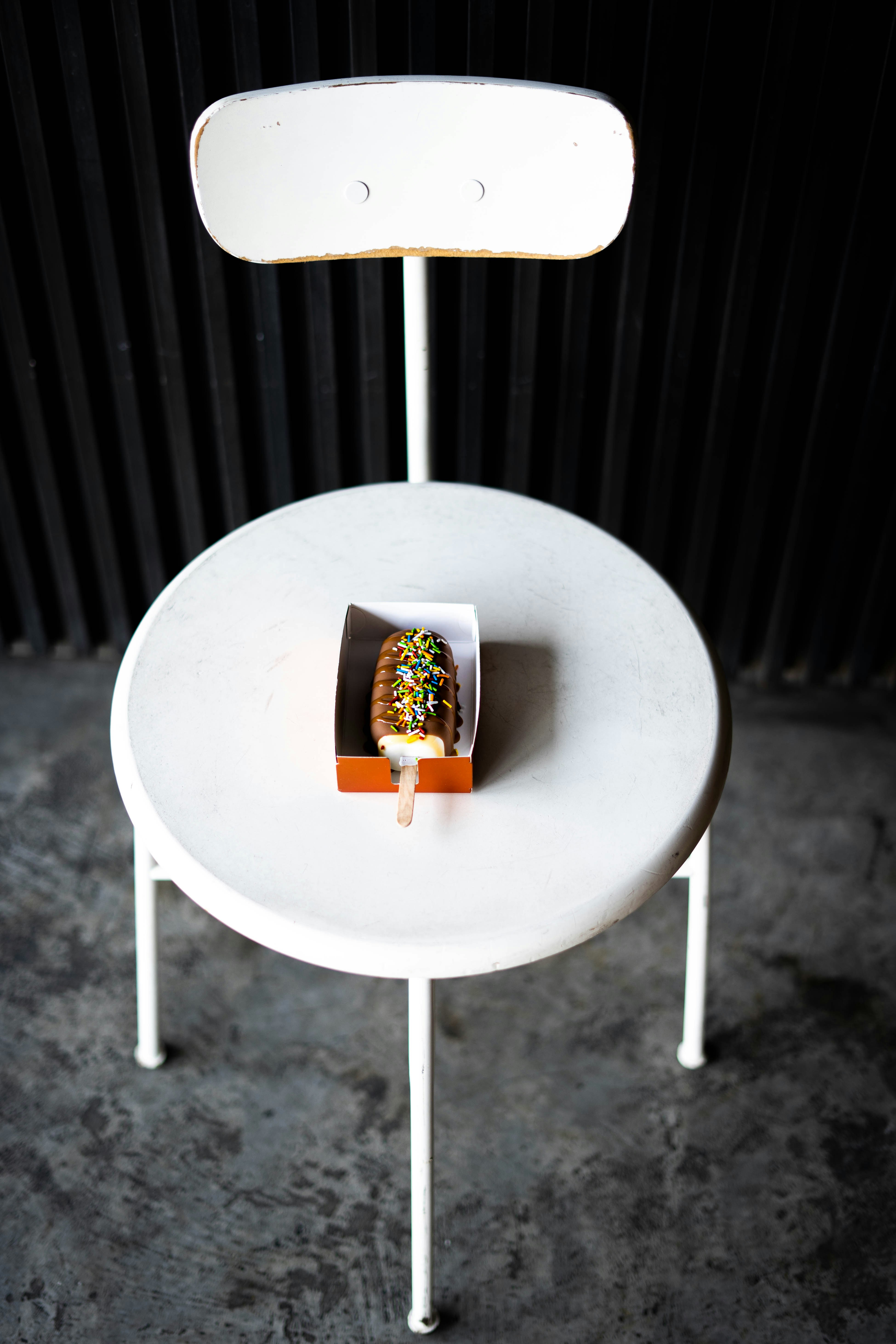 Donut in a Minimalist White Chair Still Life