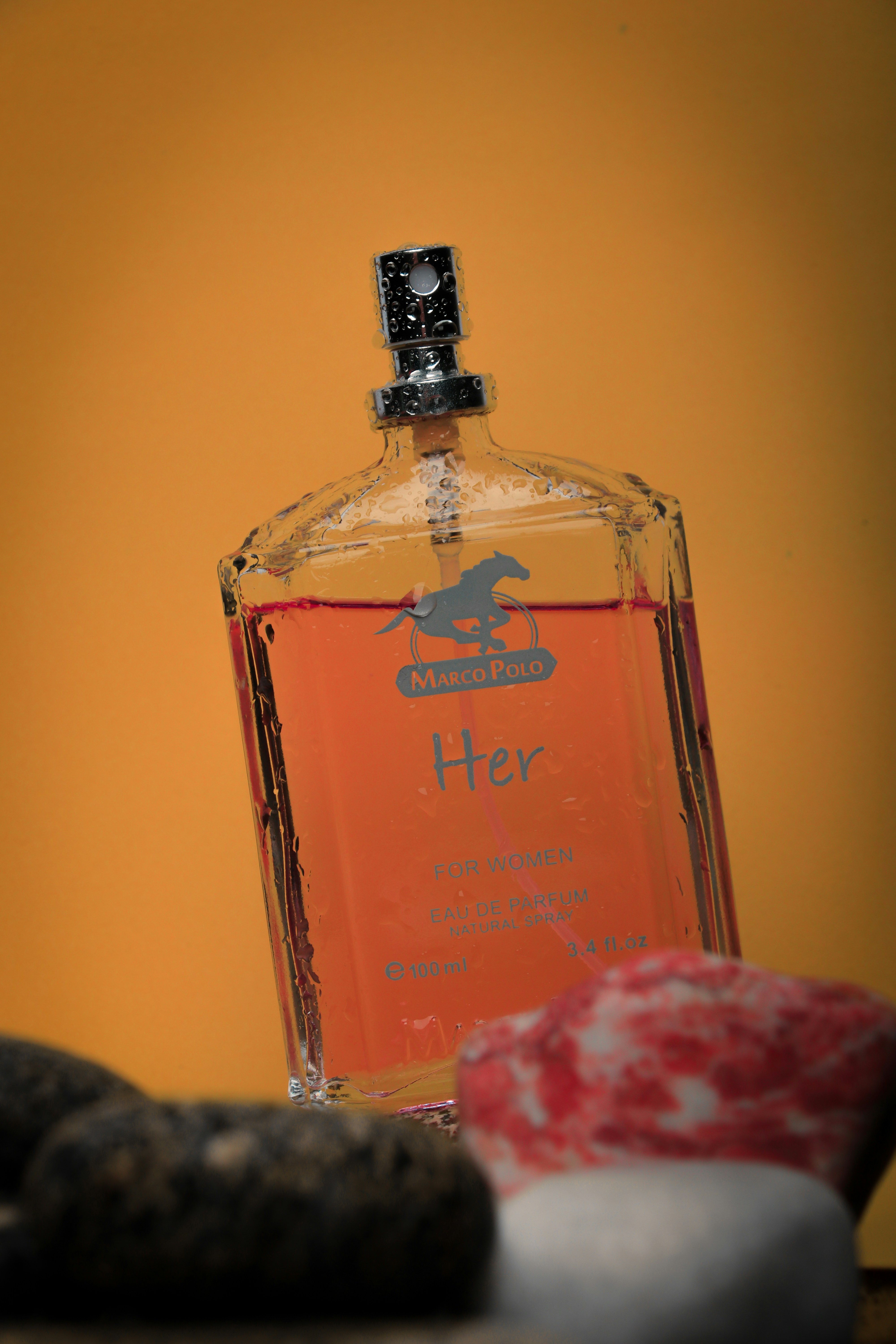 Amber Glow: a perfume bottle poised against a warm backdrop