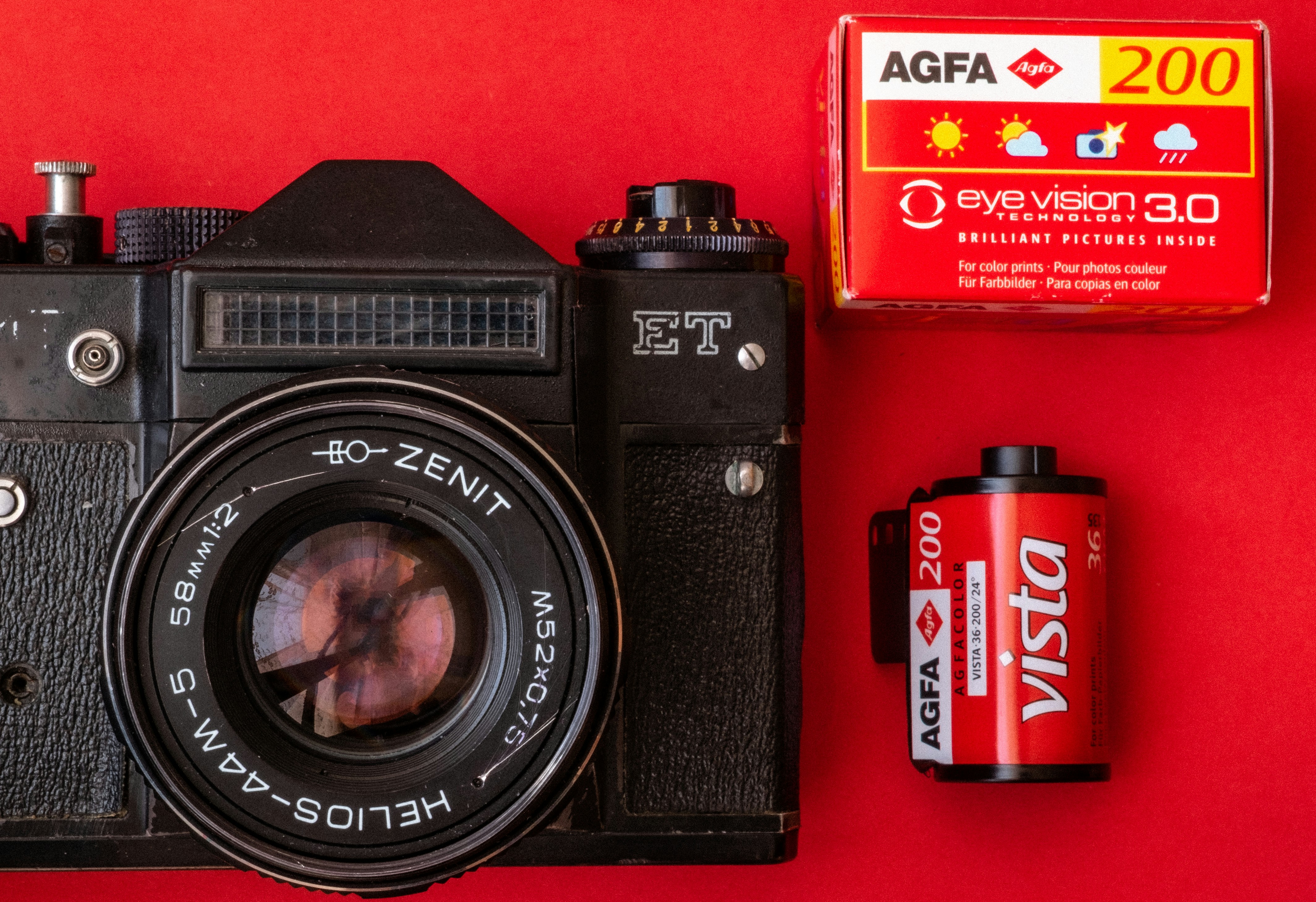 Retro DSLR by the Red Backdrop: A Moment with Vintage Zenit Gear