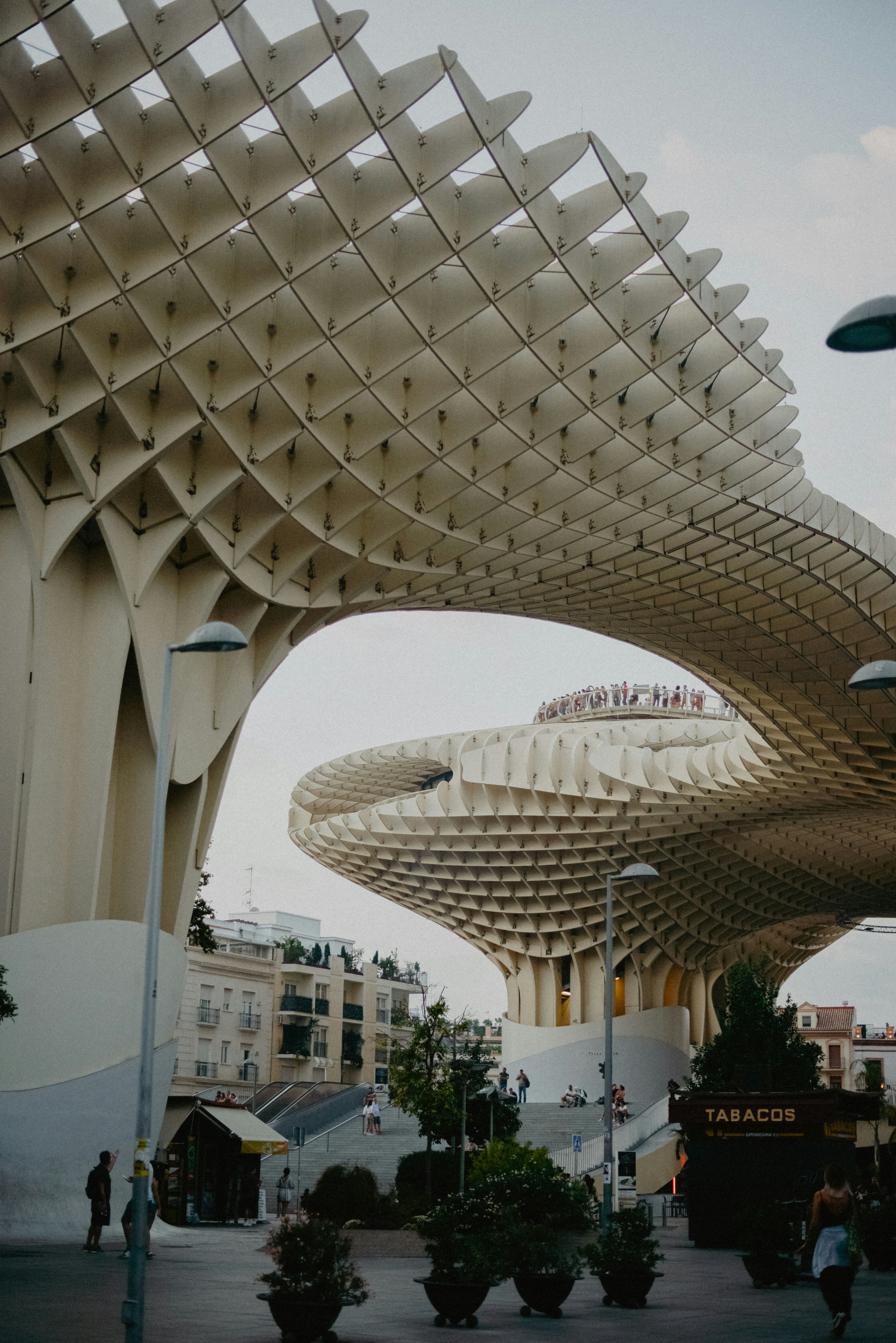 Unique architectural structure with intricate lattice design, showcasing a blend of modern design and urban life.