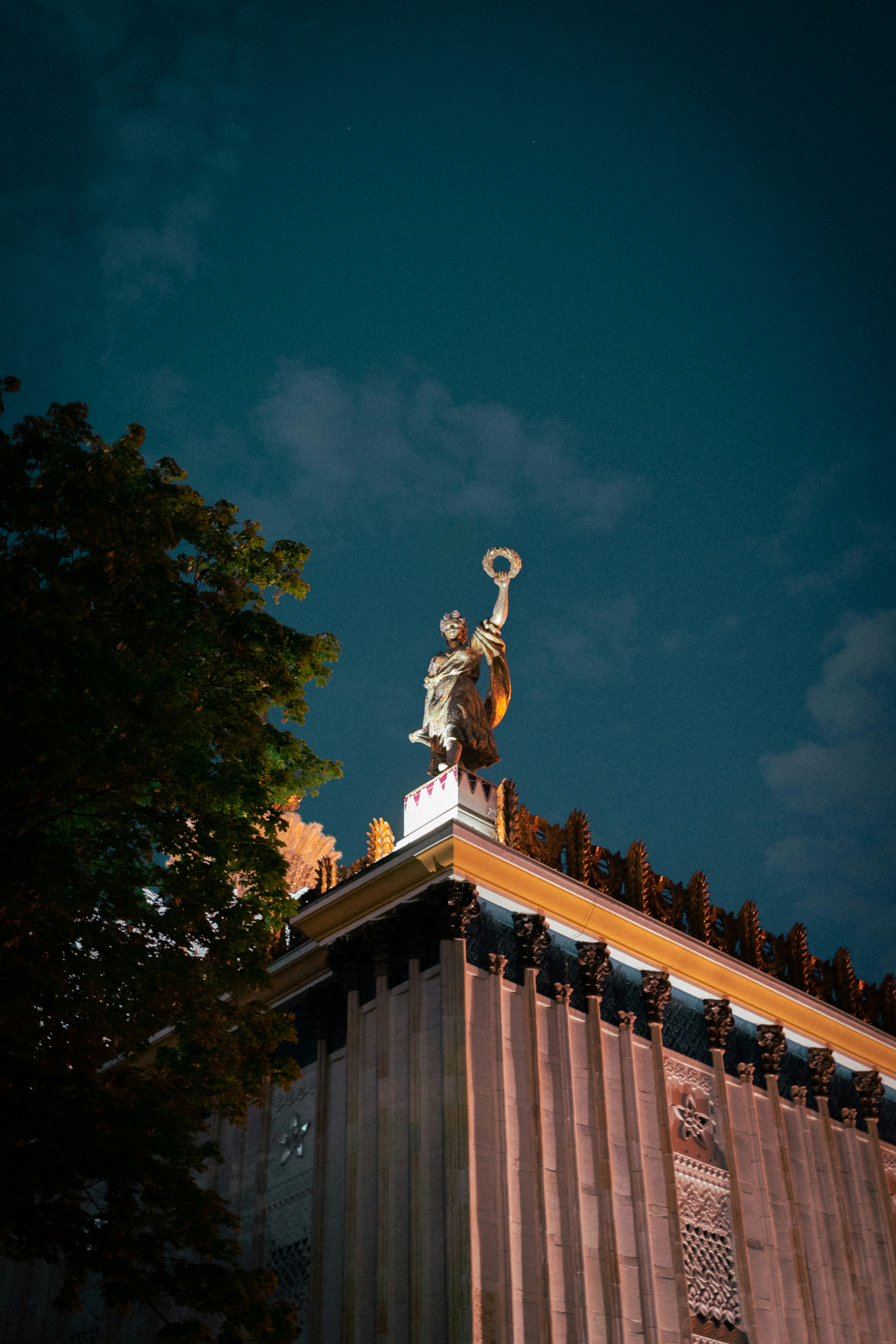 gold angel statue under blue sky during nighttime
