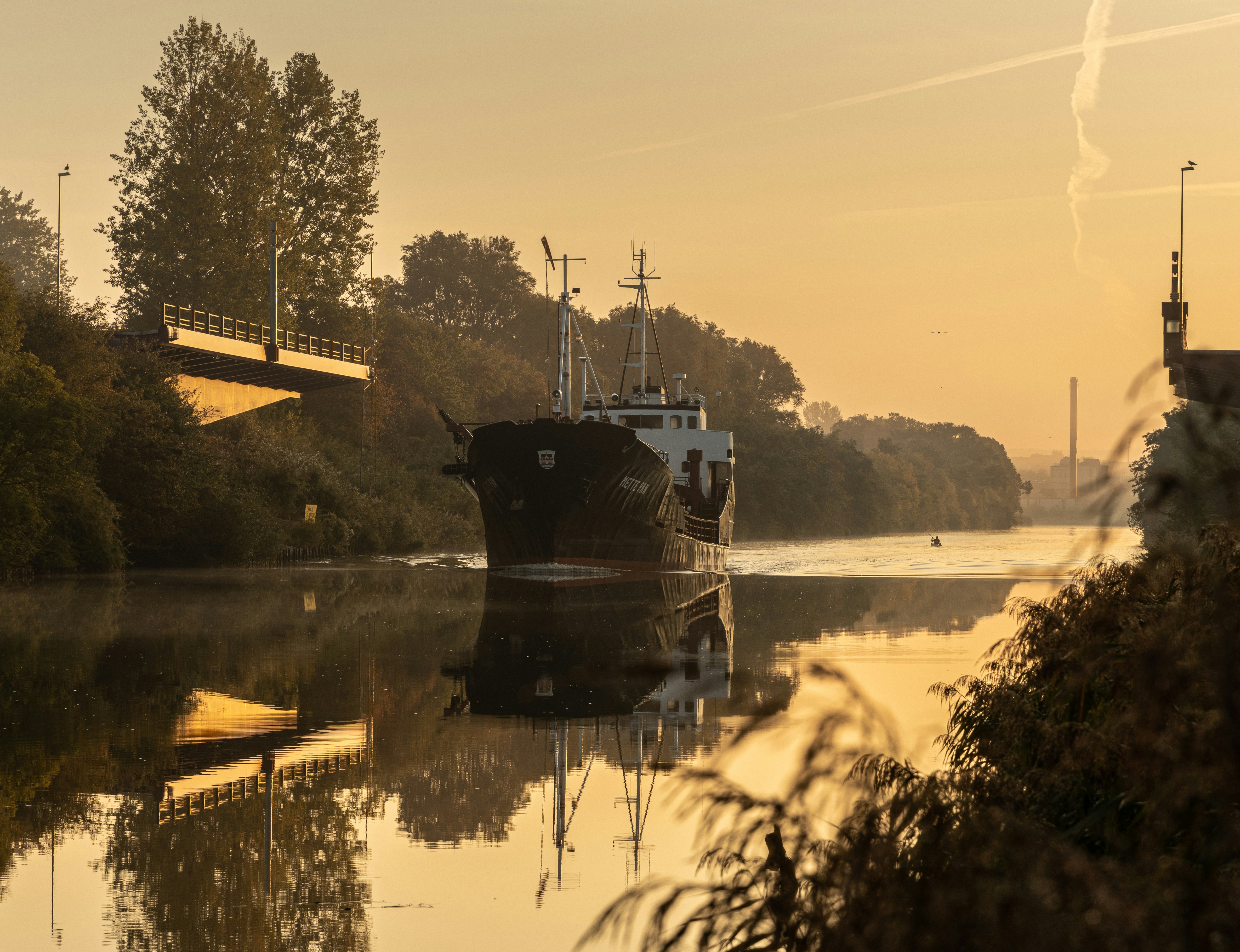 Serene Vessel on a Misty Danish Waterway