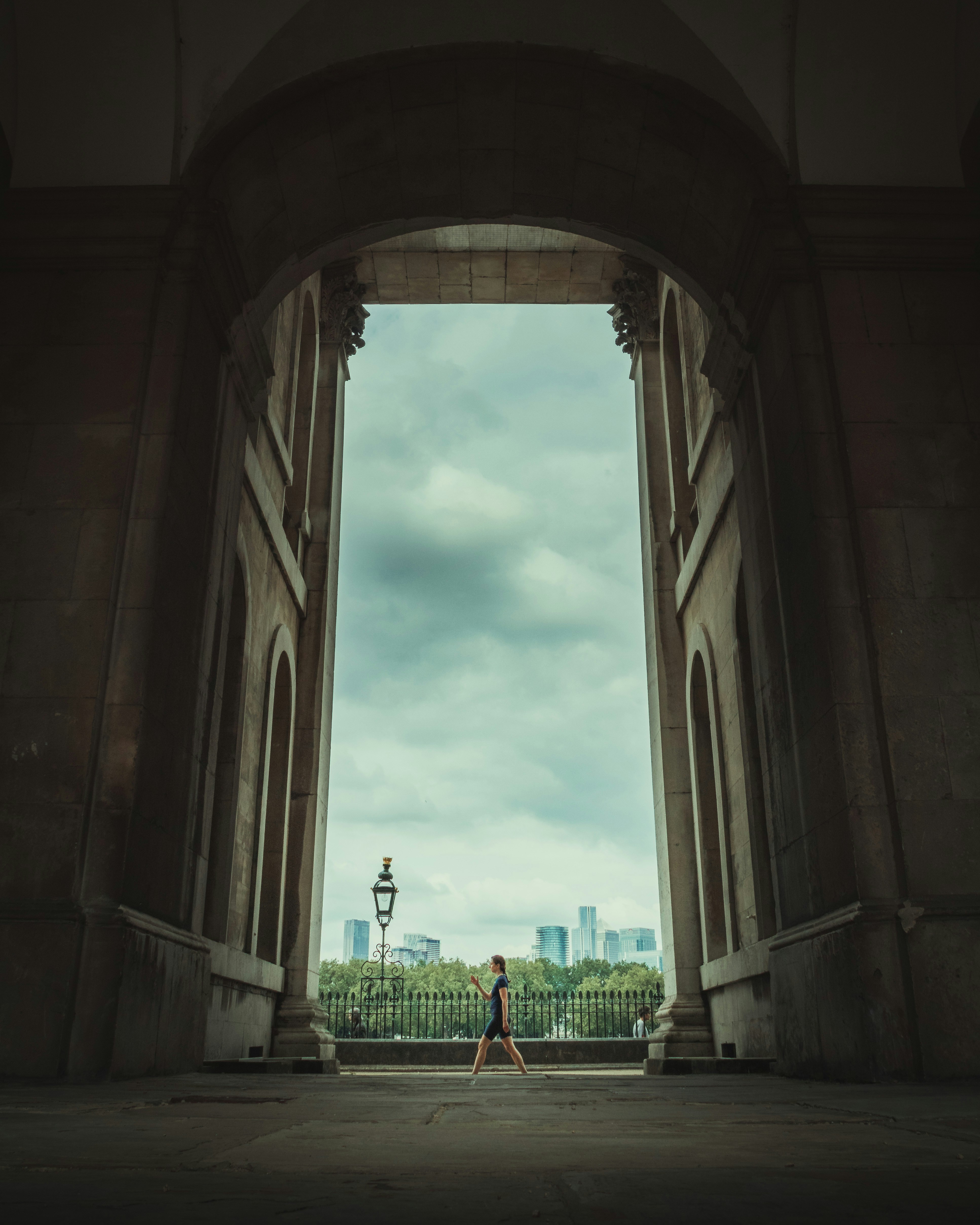 Archway to the City: A Solo Runner Beneath a Historic Portal