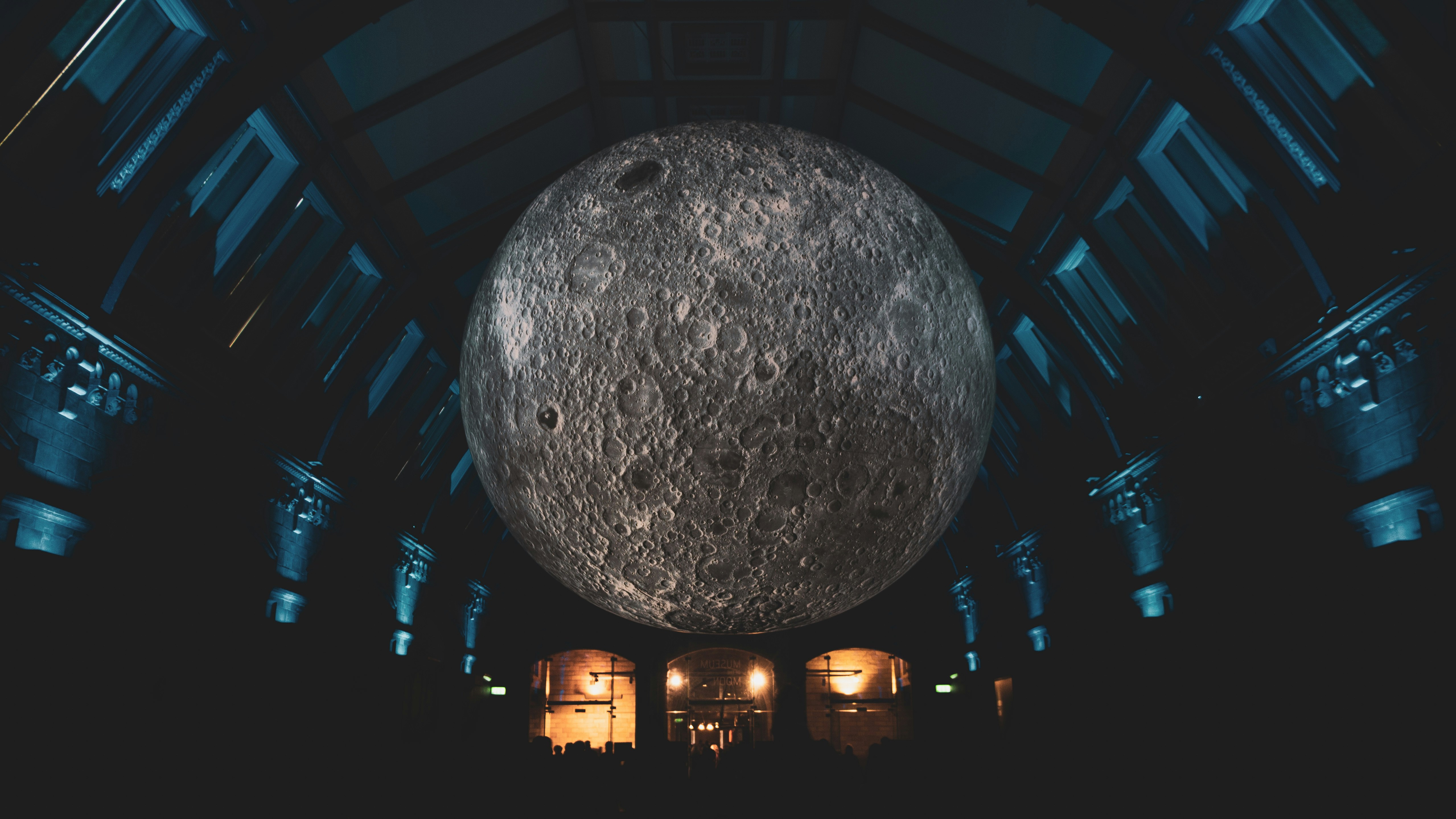 Giant Moon Over a Velvet-Blue Atrium with a Gatehouse Glow