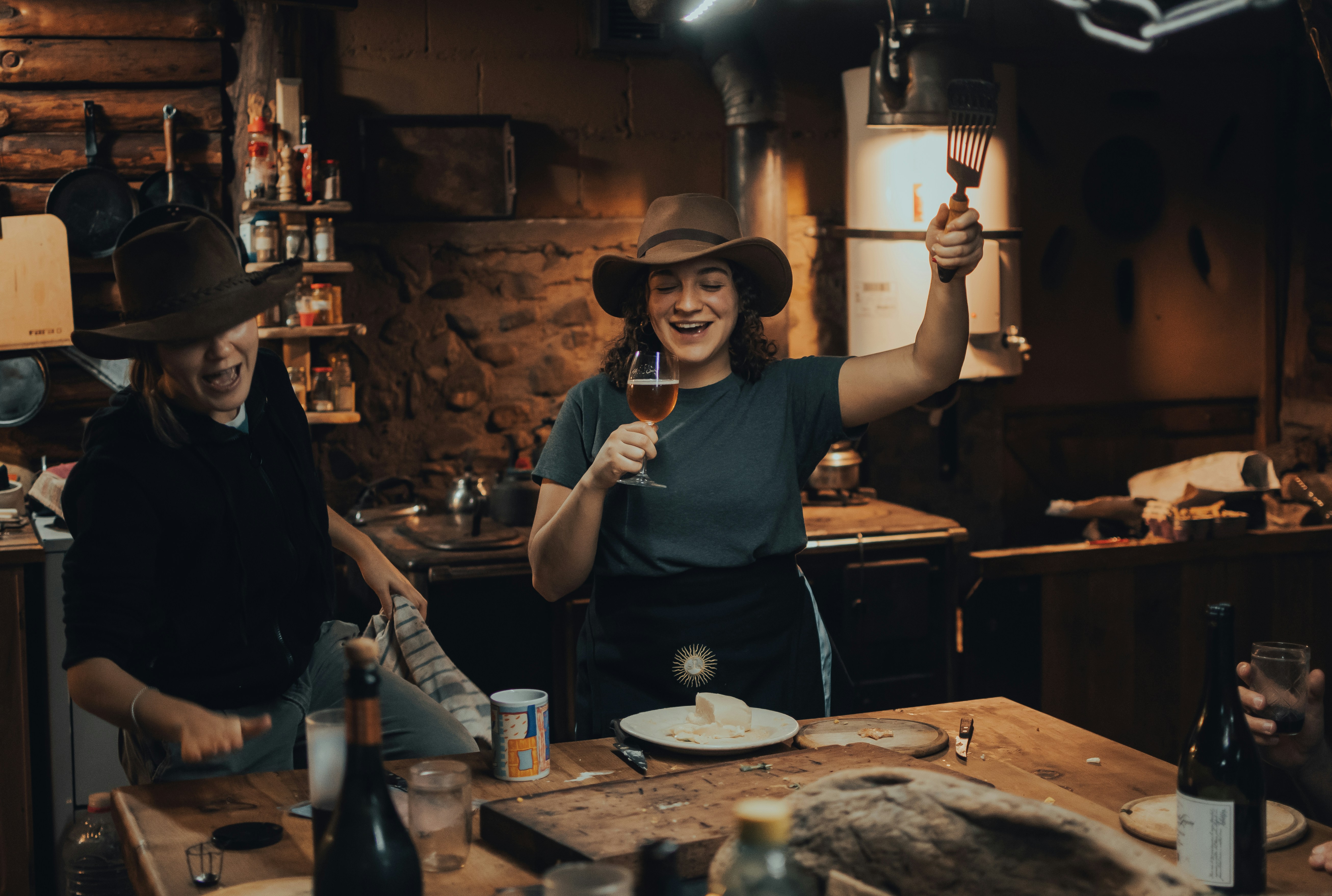 woman in black crew neck t-shirt and black hat holding bottle