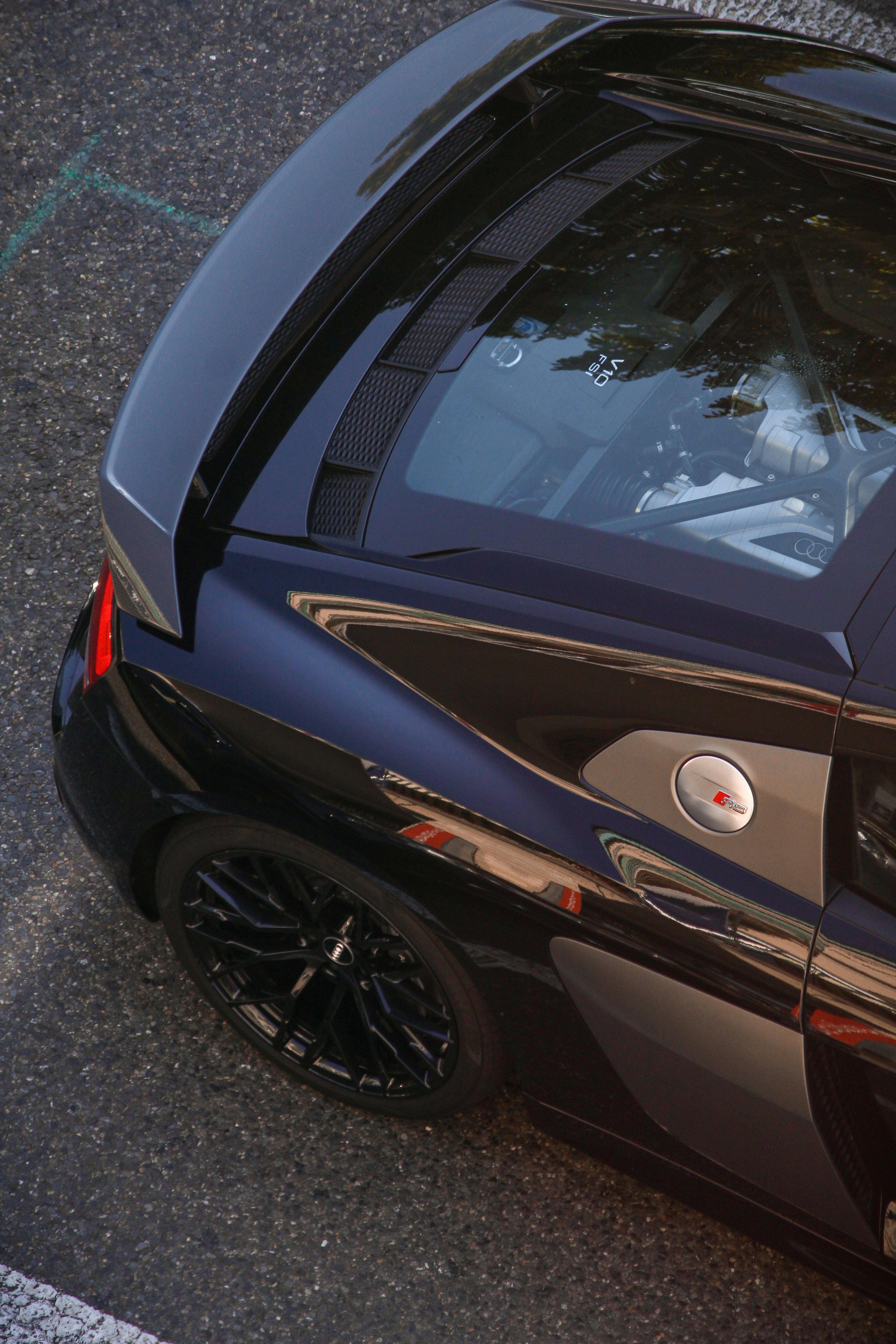Midnight Blue Coupe: Chrome Badge and Vented Rear Quarter in Focus
