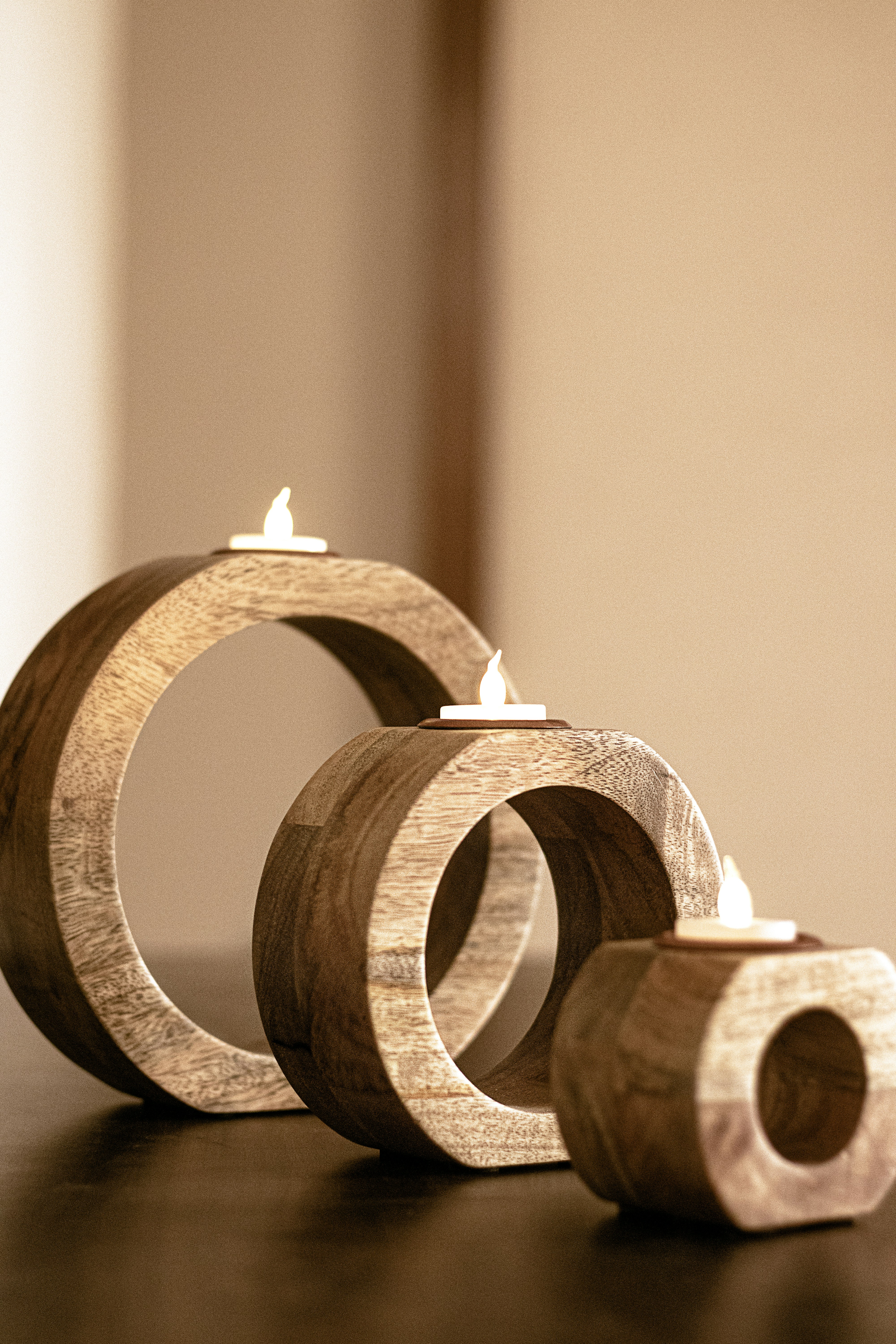 Three Wooden Rings Alight: A Minimalist Tealight Still Life