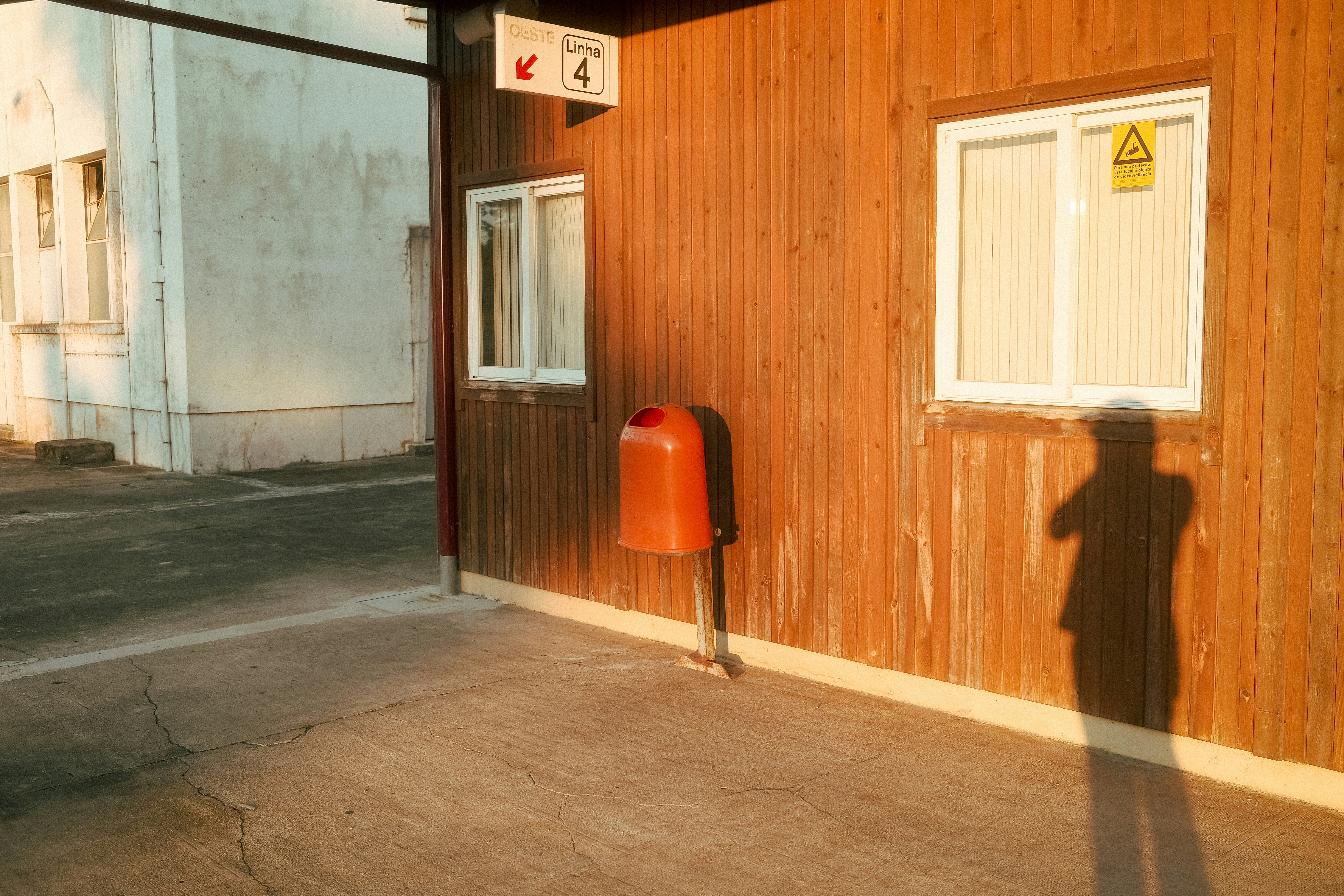 Shadow on the Wooden Wall: A Tilted Evening at the Mail Depot