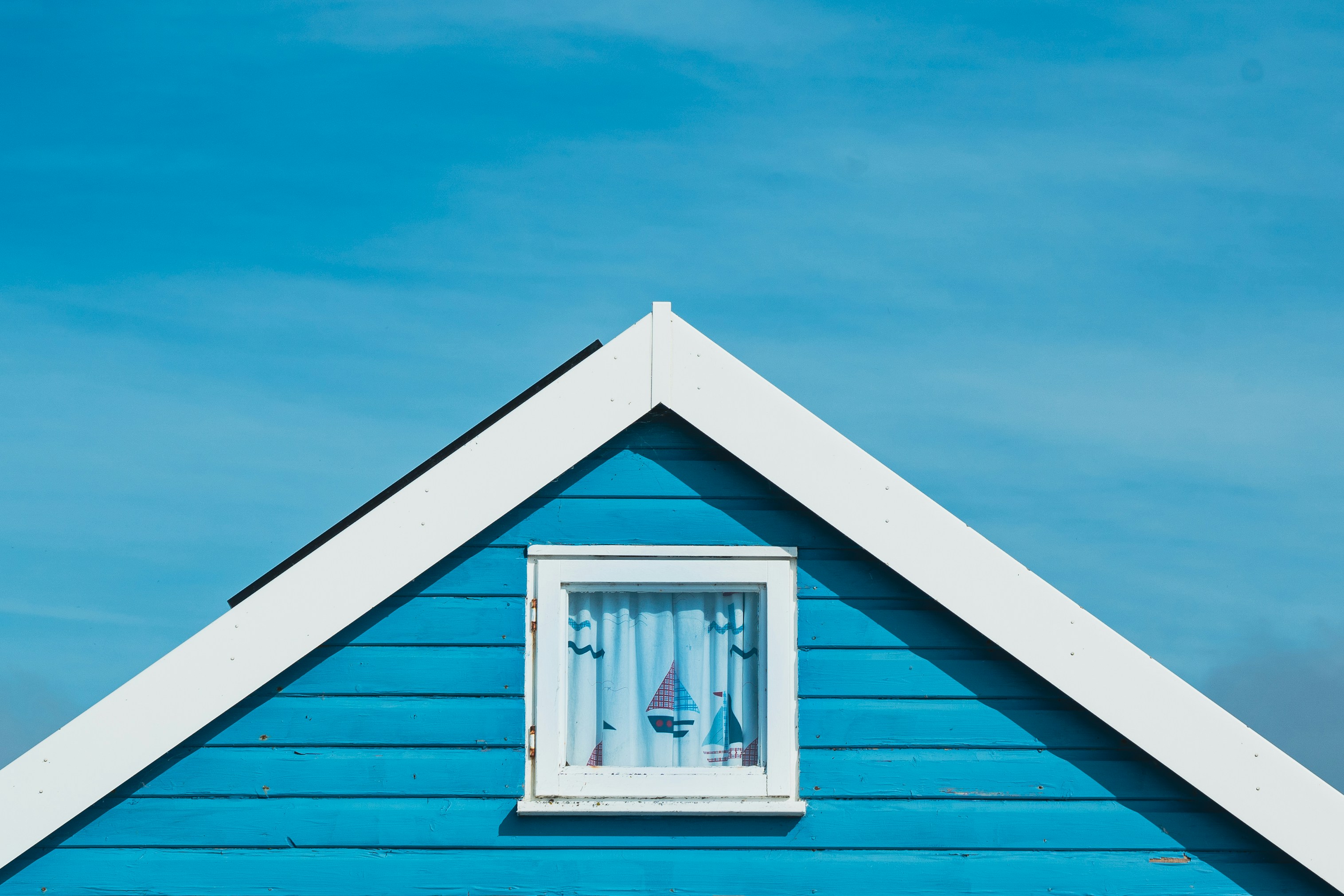Cerulean Gable Window: Peak-Centered Portrait of a Bright Blue House