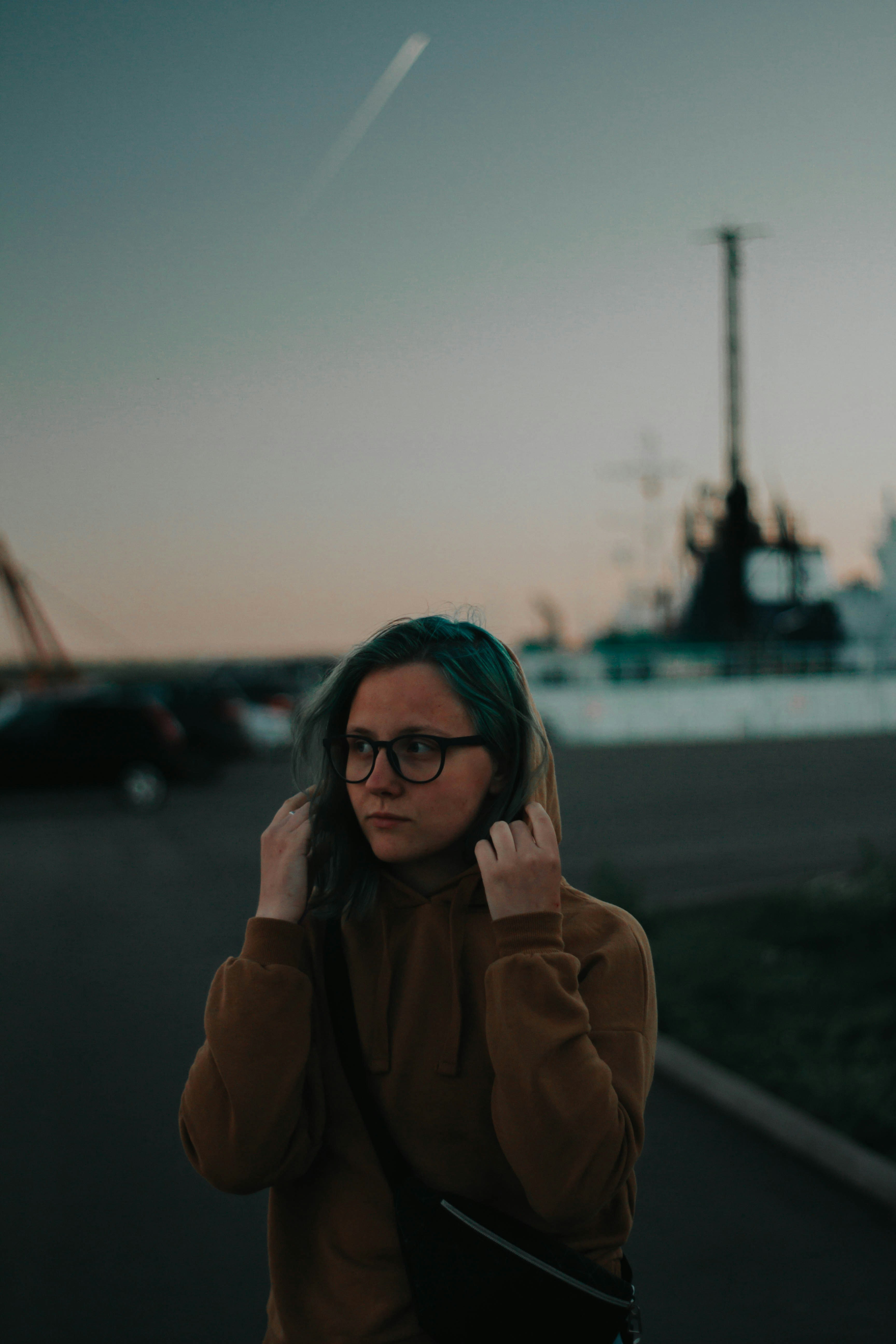 Dockside Contemplation: A Portrait of Focus Amid Harbor Lights