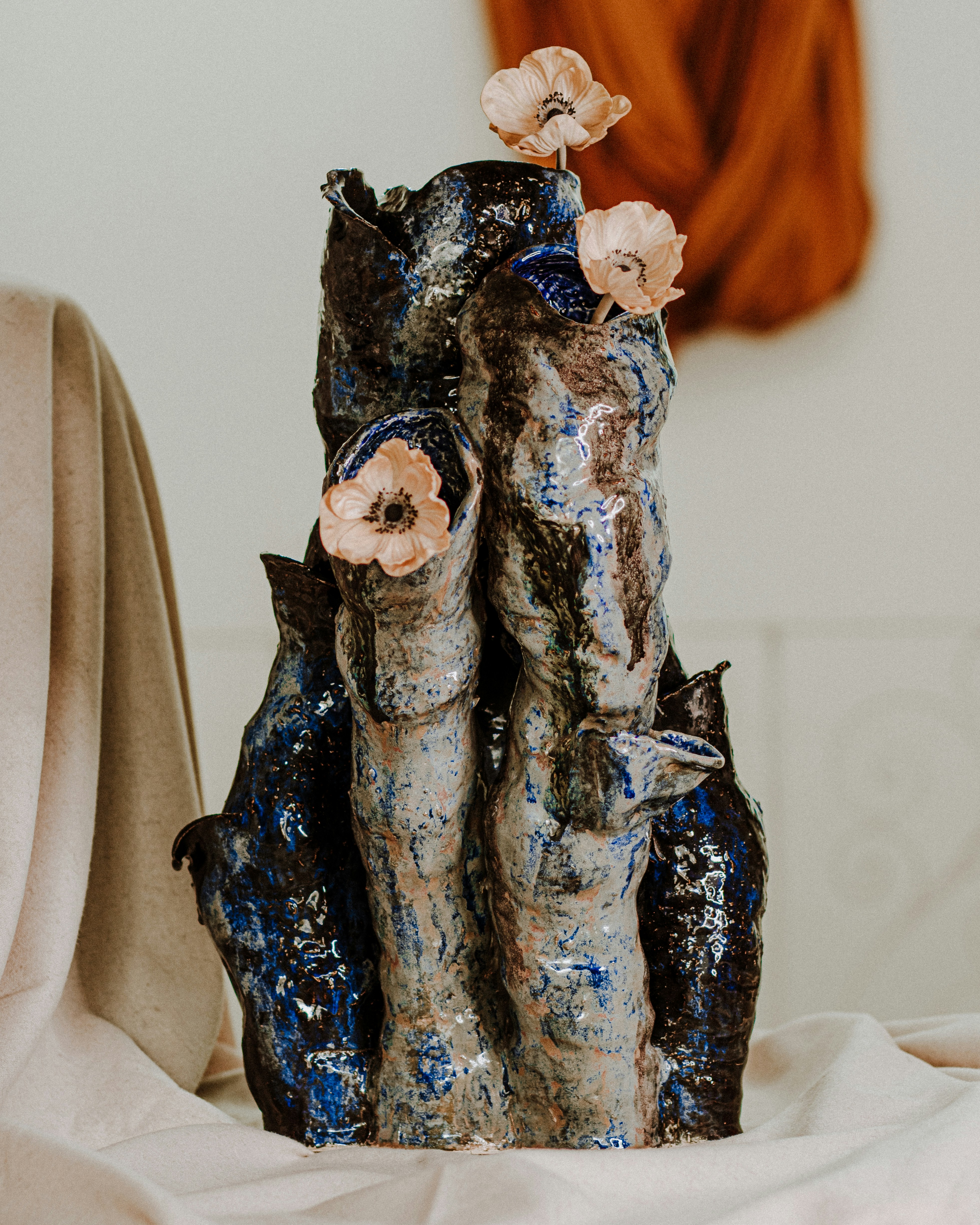 Ceramic Fingers: A Surreal Vase Sculpted with Floral Echoes