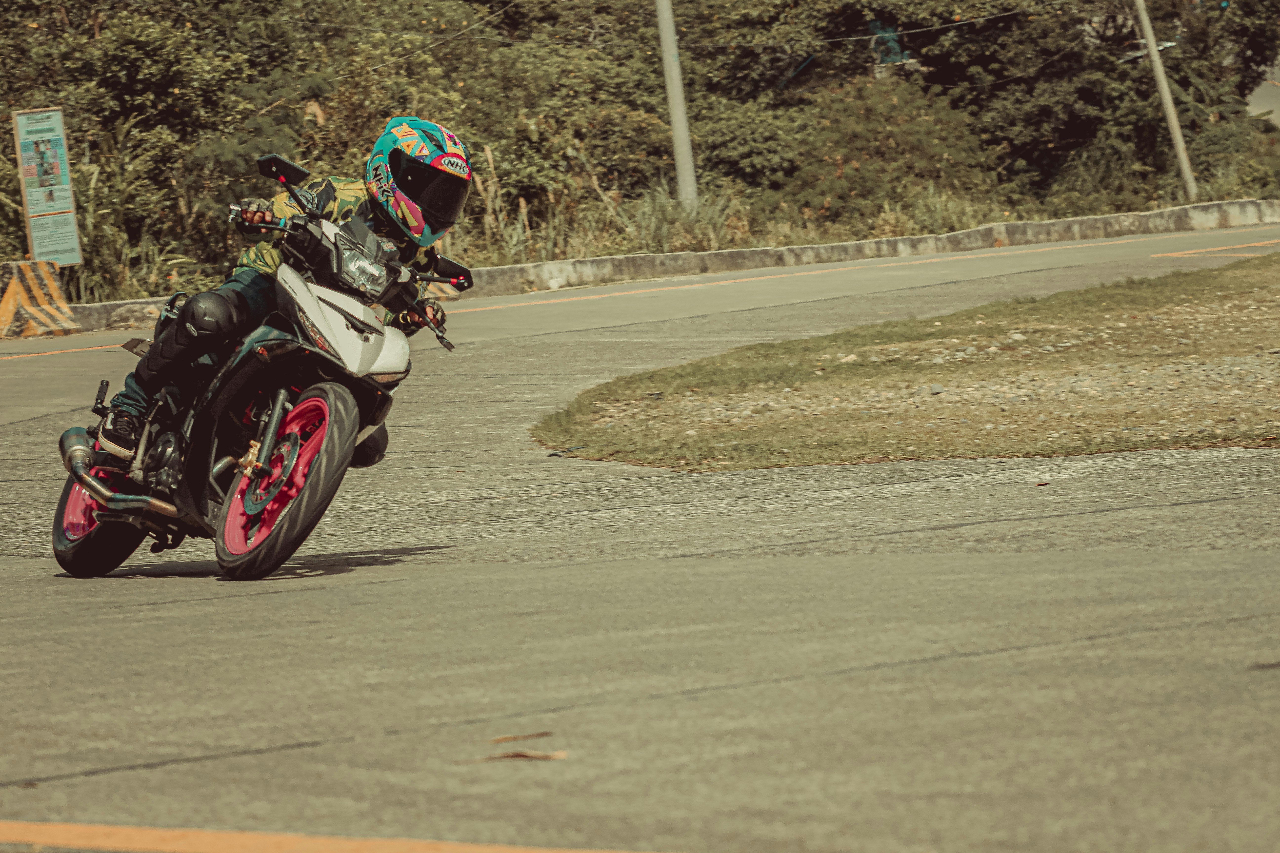 Pink-Rim Drift: A Rider Leans Through a Quiet Curve