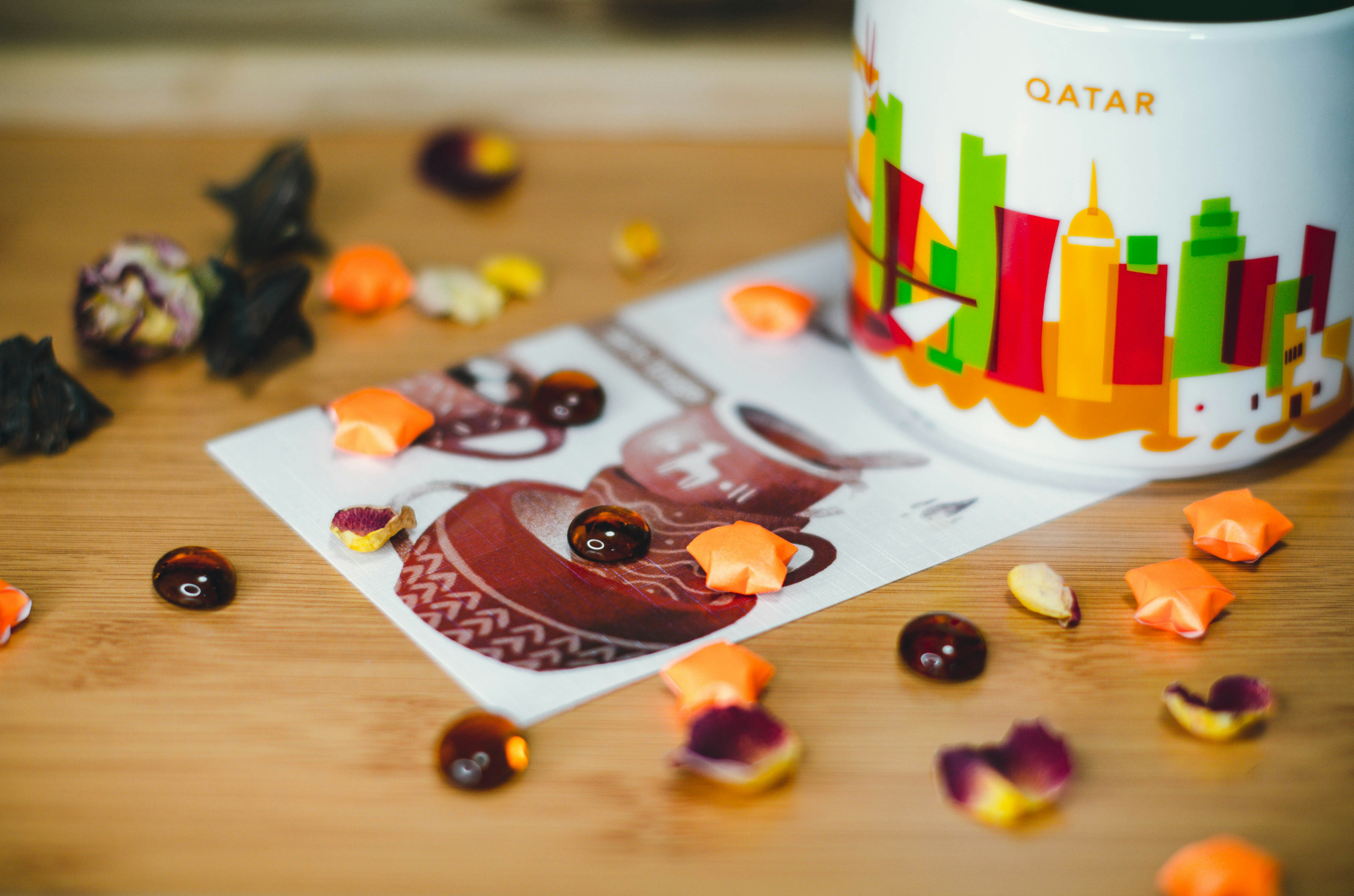 Colorful Qatar Cup and Hand-Crafted Treats on a Rustic Wooden Surface