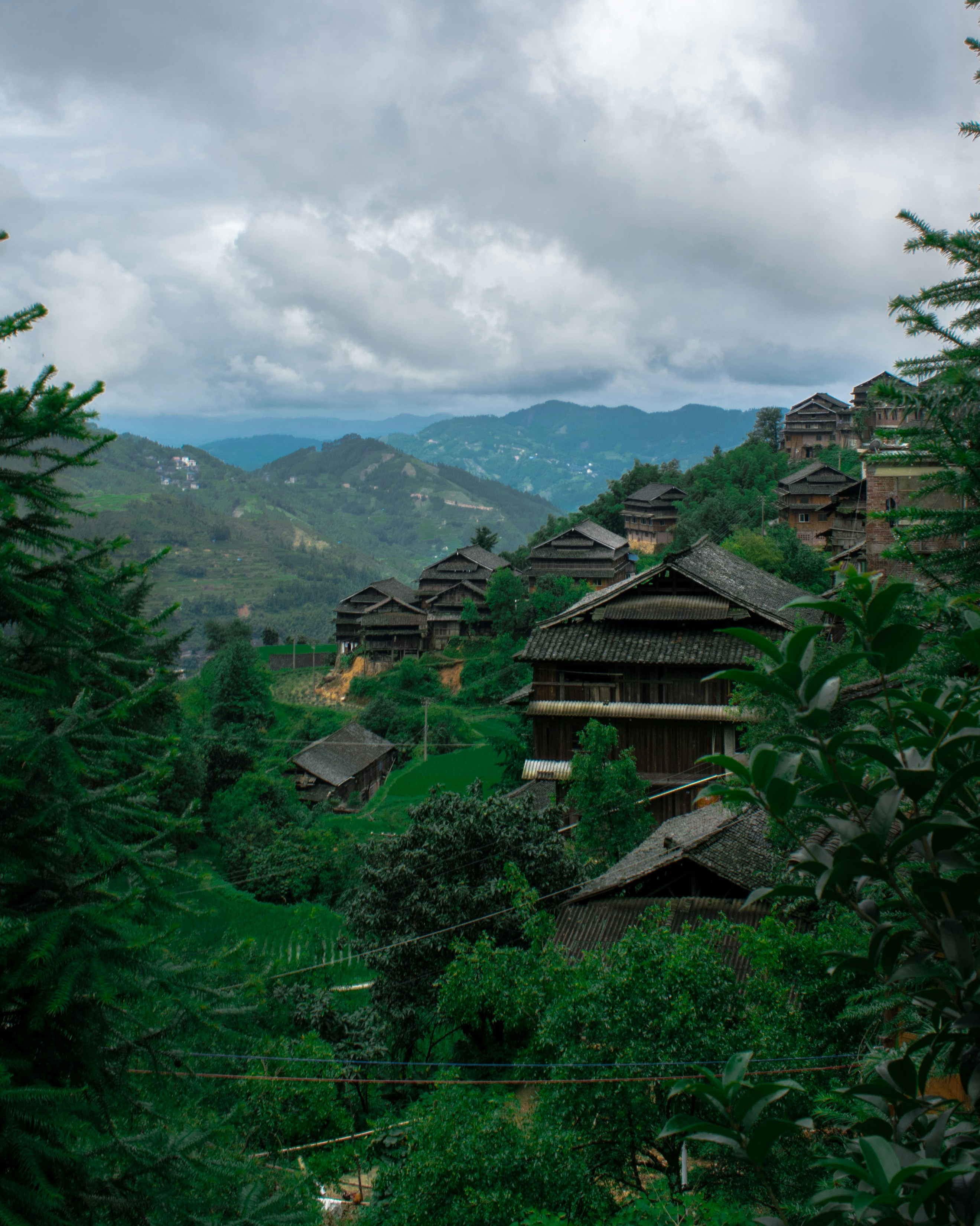 Terraced hillside village under a moody, clouded sky