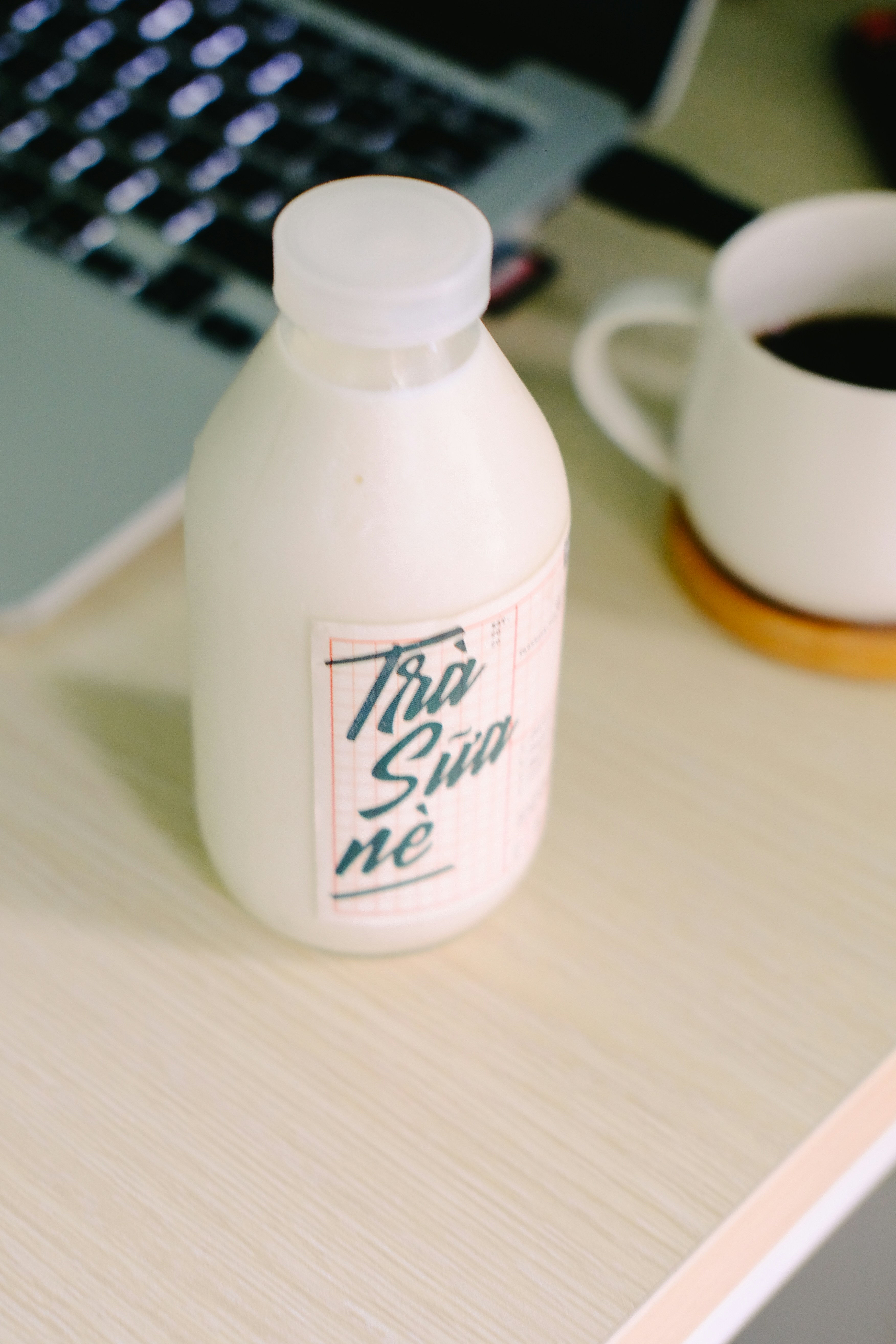 white plastic bottle on white table