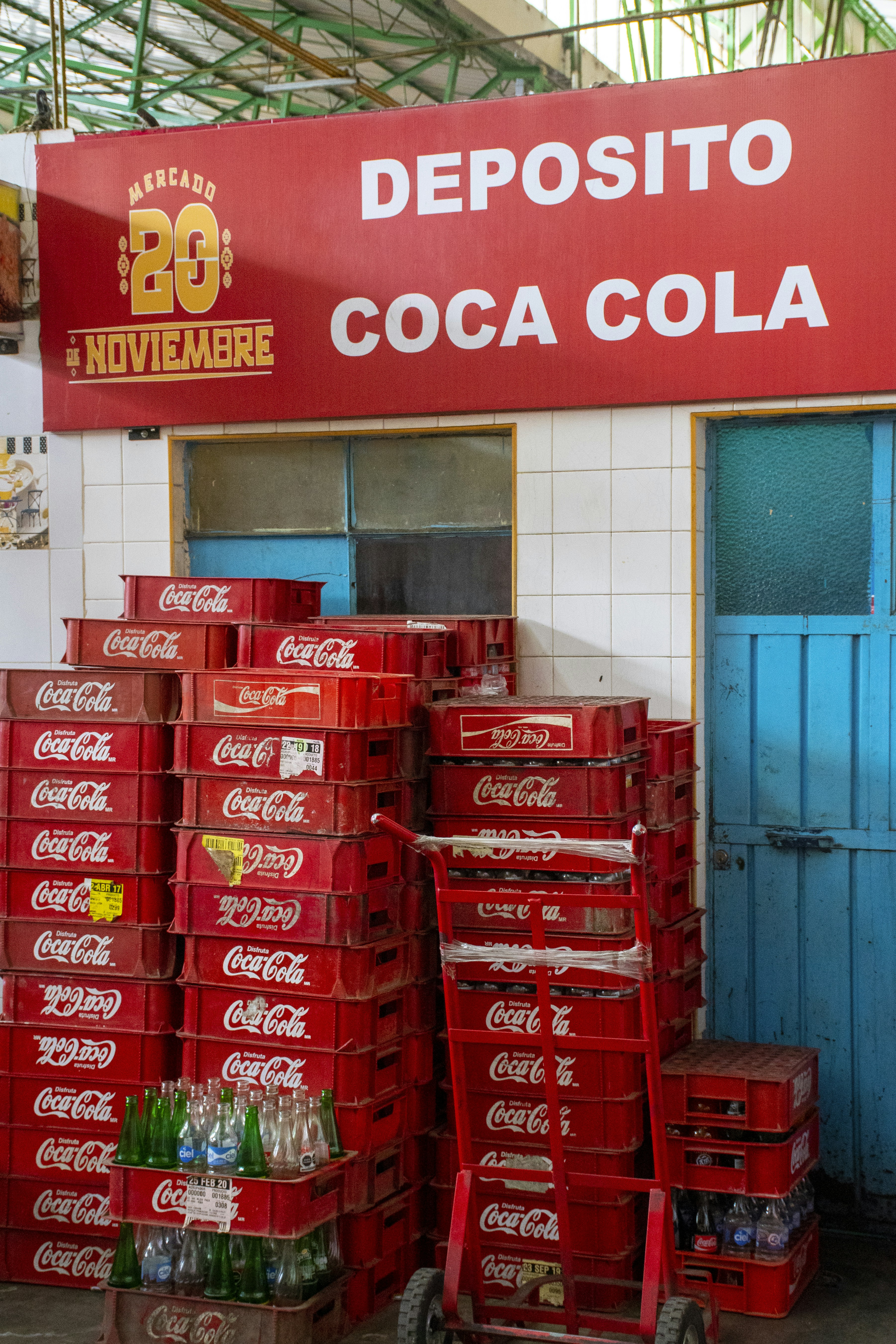 Crates, Bottles, and a Coca-Cola Depot Sign: A Street-Level Market Scene