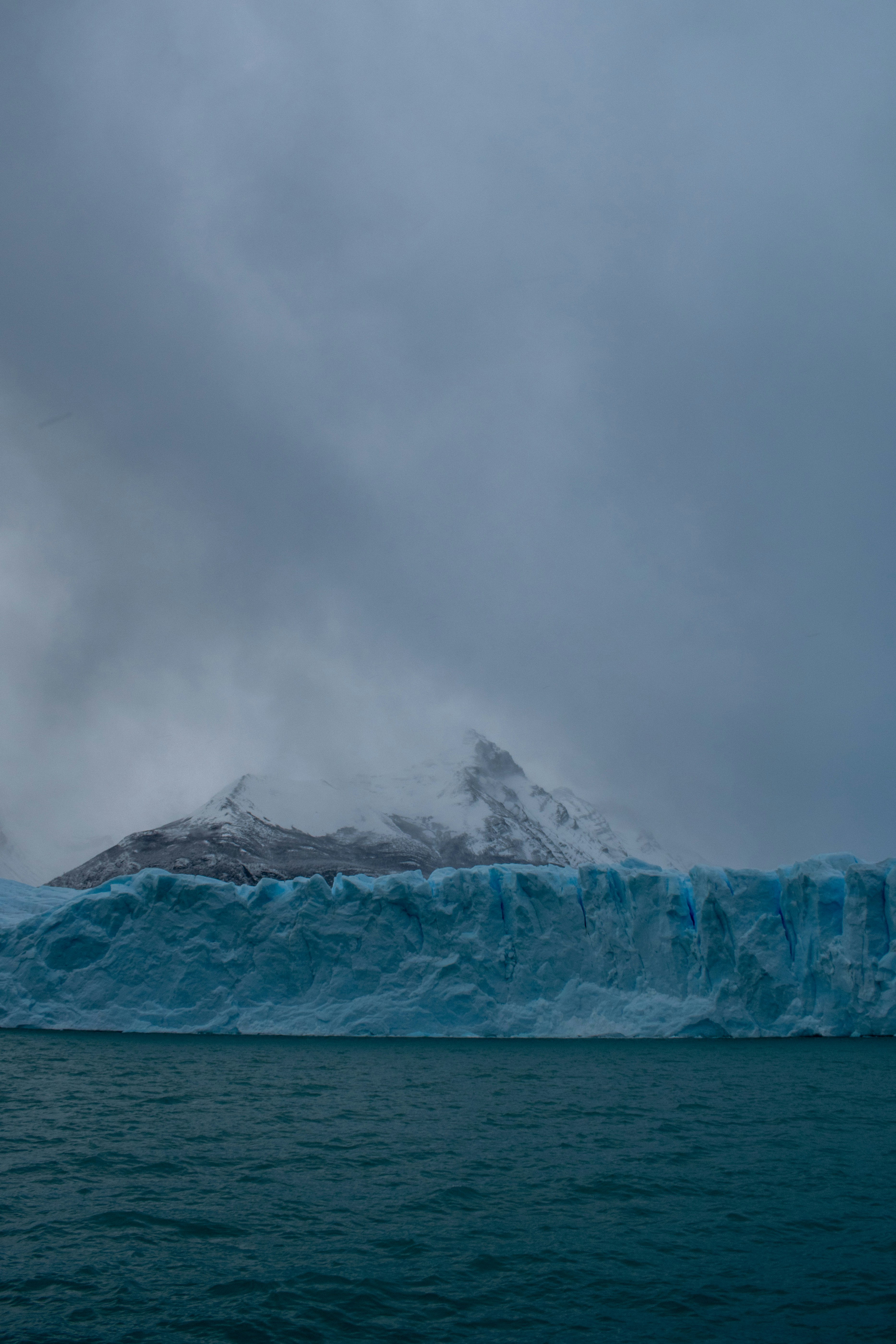 Blue Edge of Silence: Glacier Boundary Beneath a Looming Sky