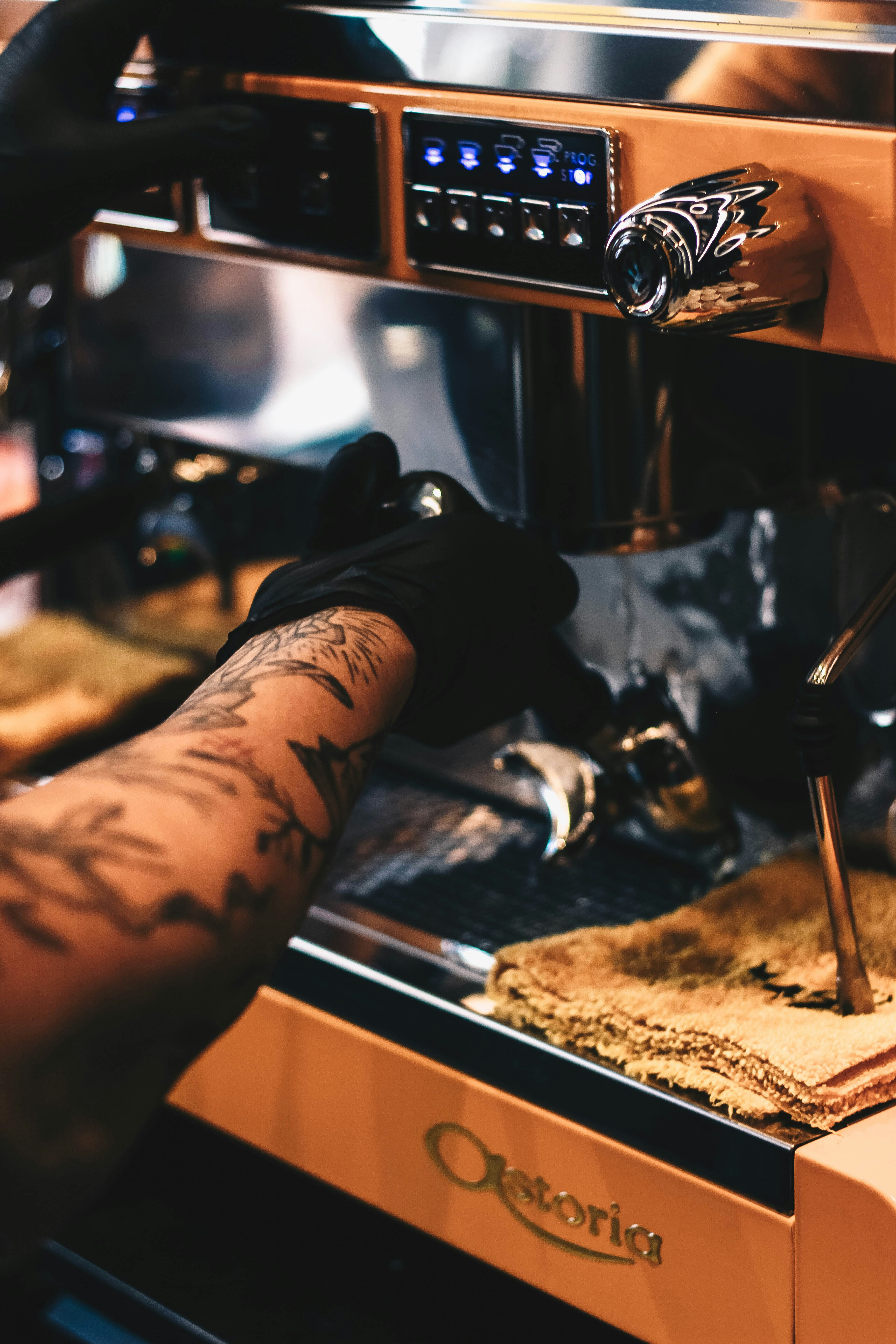 Chrome, Steam, and Ink: A Tattooed Hand at the Espresso Machine