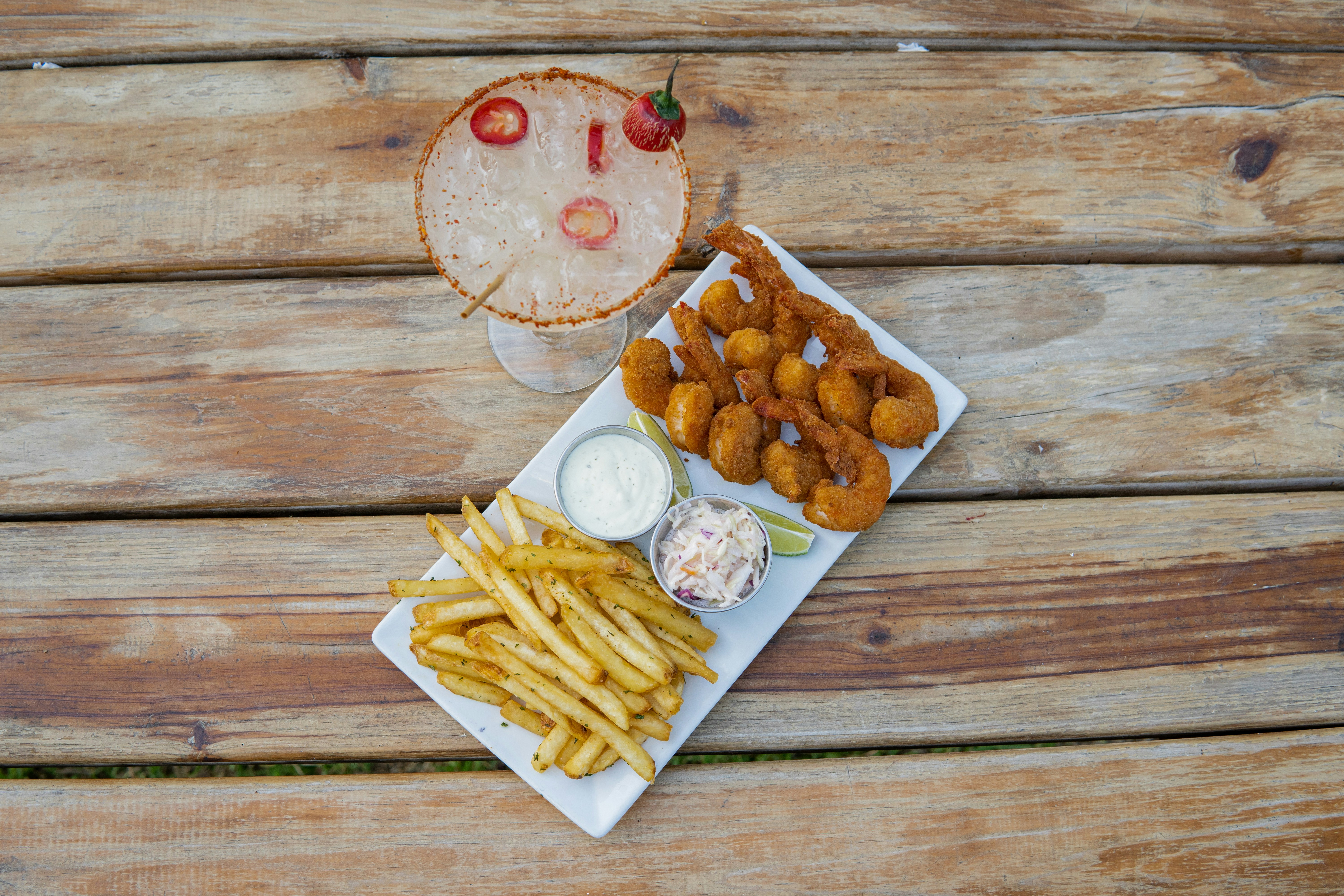 Diagonal Feast: Golden Fries and Crispy Bites on a Rustic Wood Table