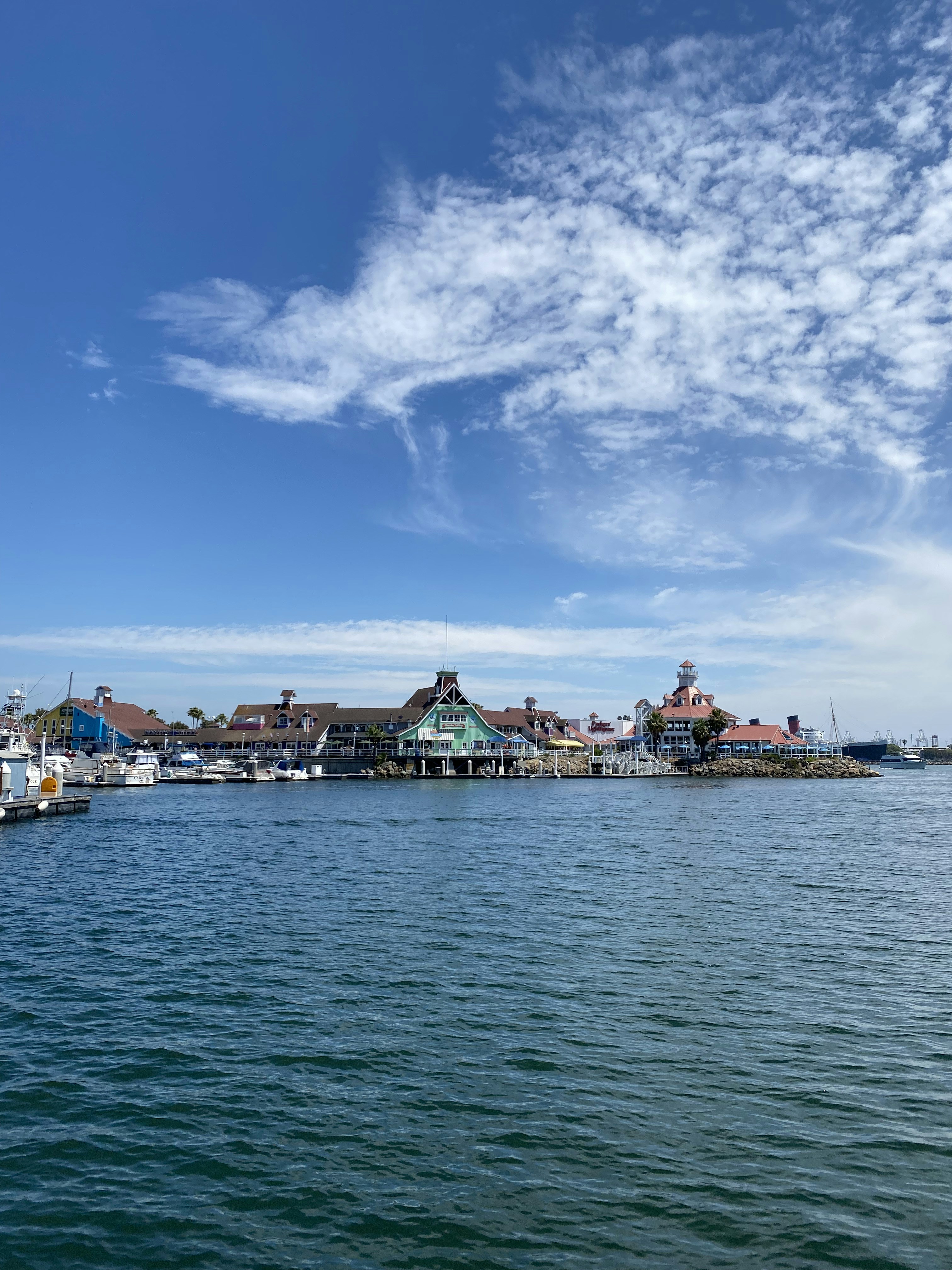 Harborfront in Sunlight: Colorful Shacks and Calm Waters