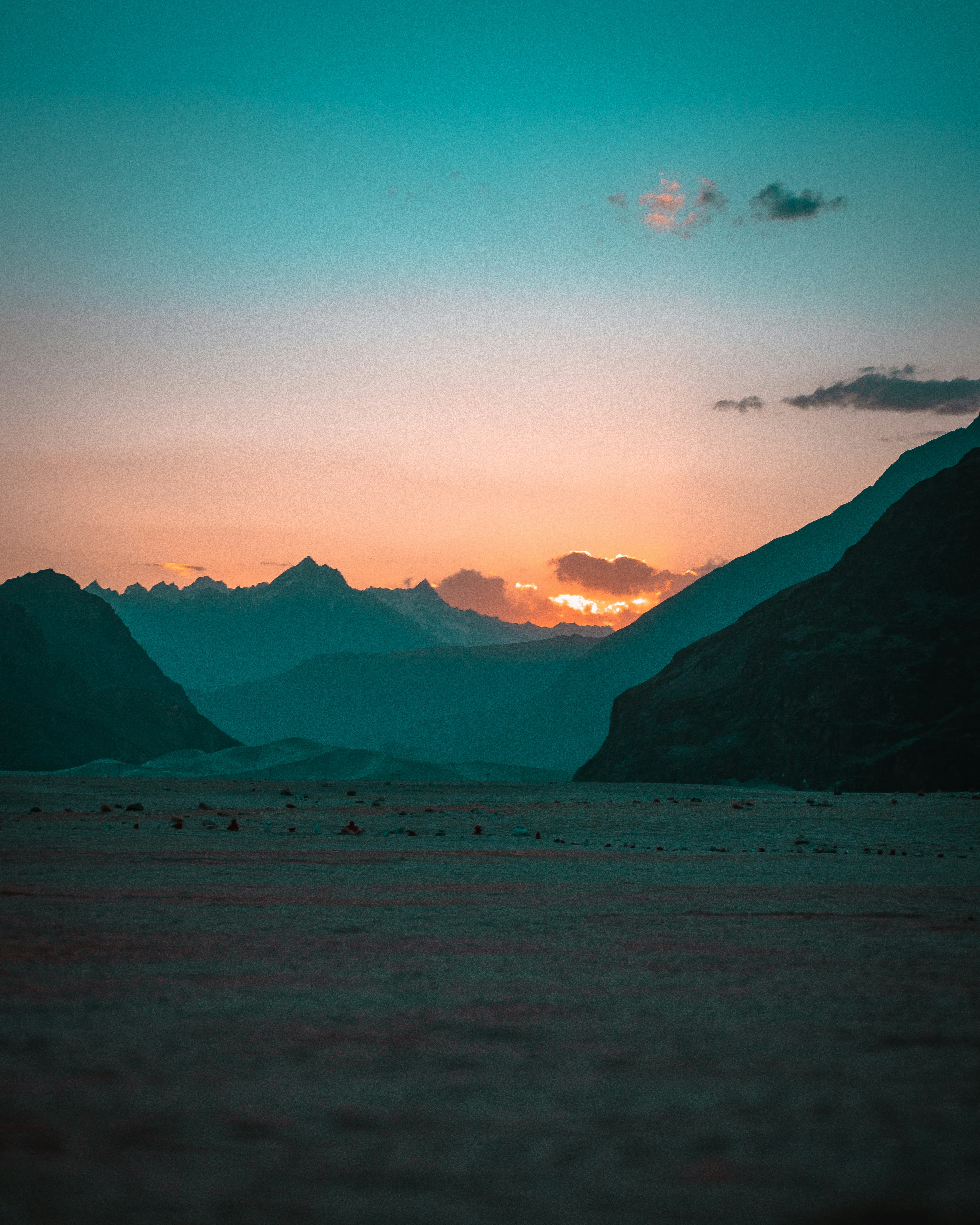 Ember at the Pass: Sunset Cutting Through a Distant Mountain Valley