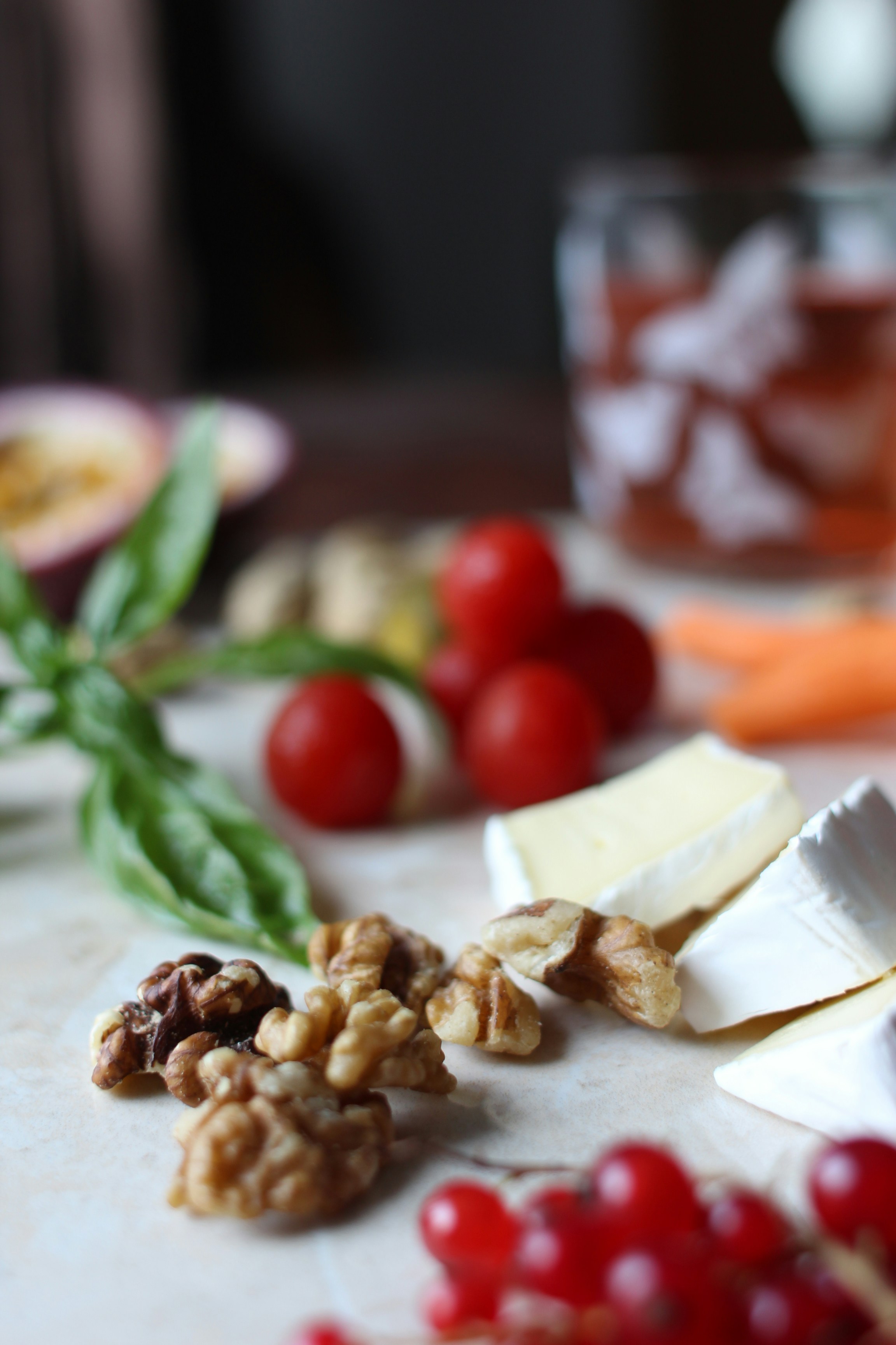 Brie, Walnuts, and Crimson Berries: A Rustic Still-Life Cheese Board