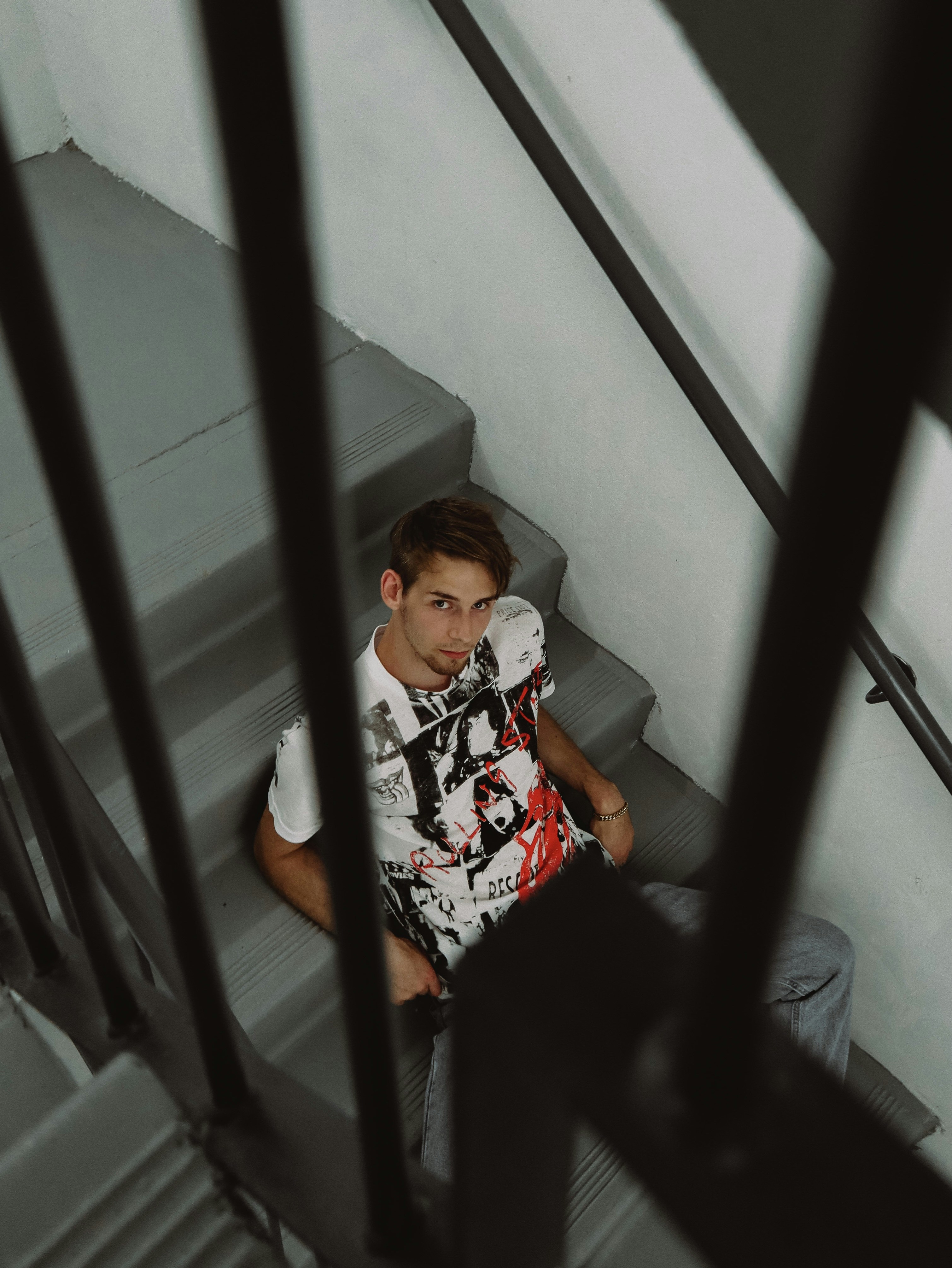 Glimpse Through the Rails: A Stairwell Portrait