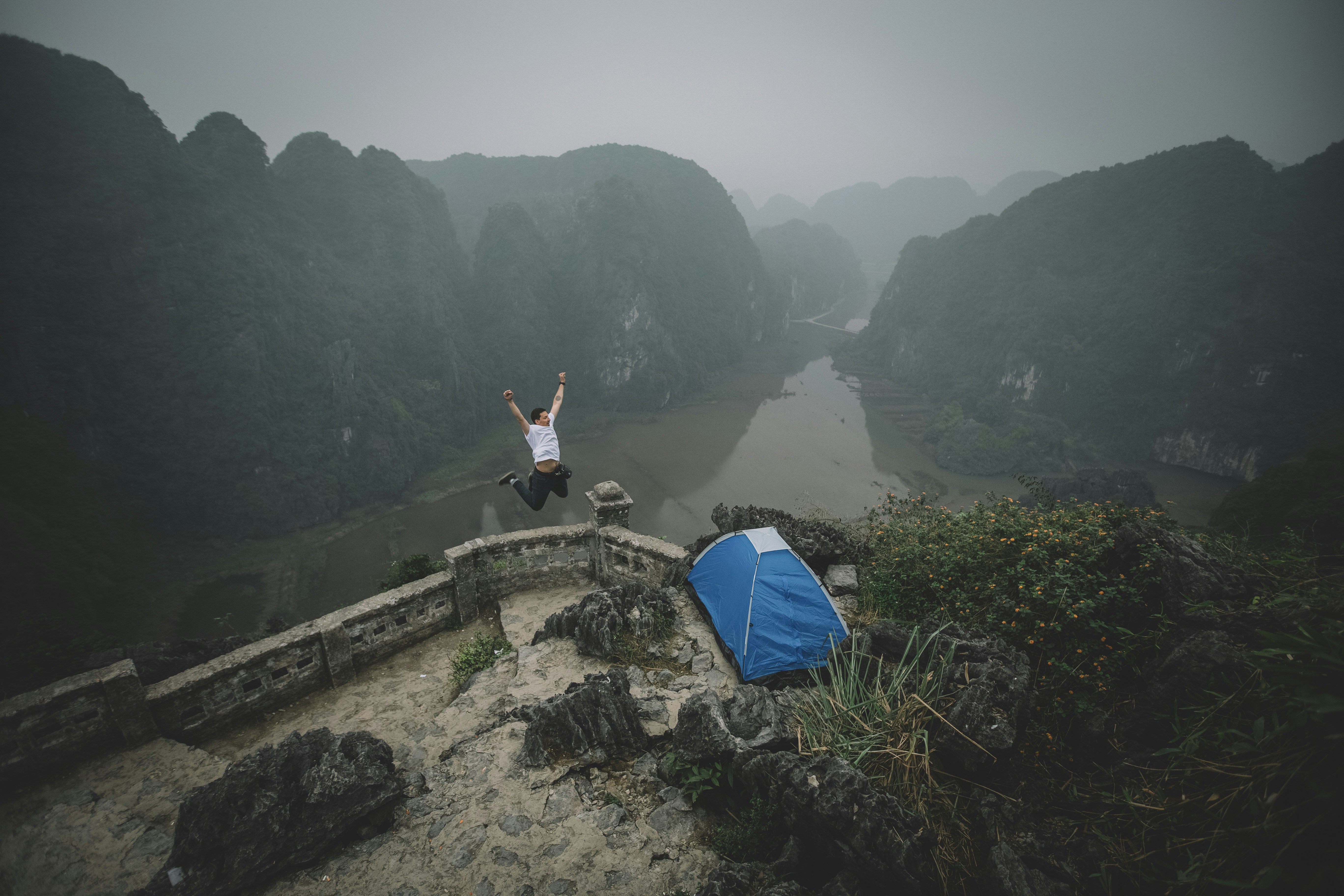 Leap Over the Mist: Cliffside Camp Above a Winding Gorge