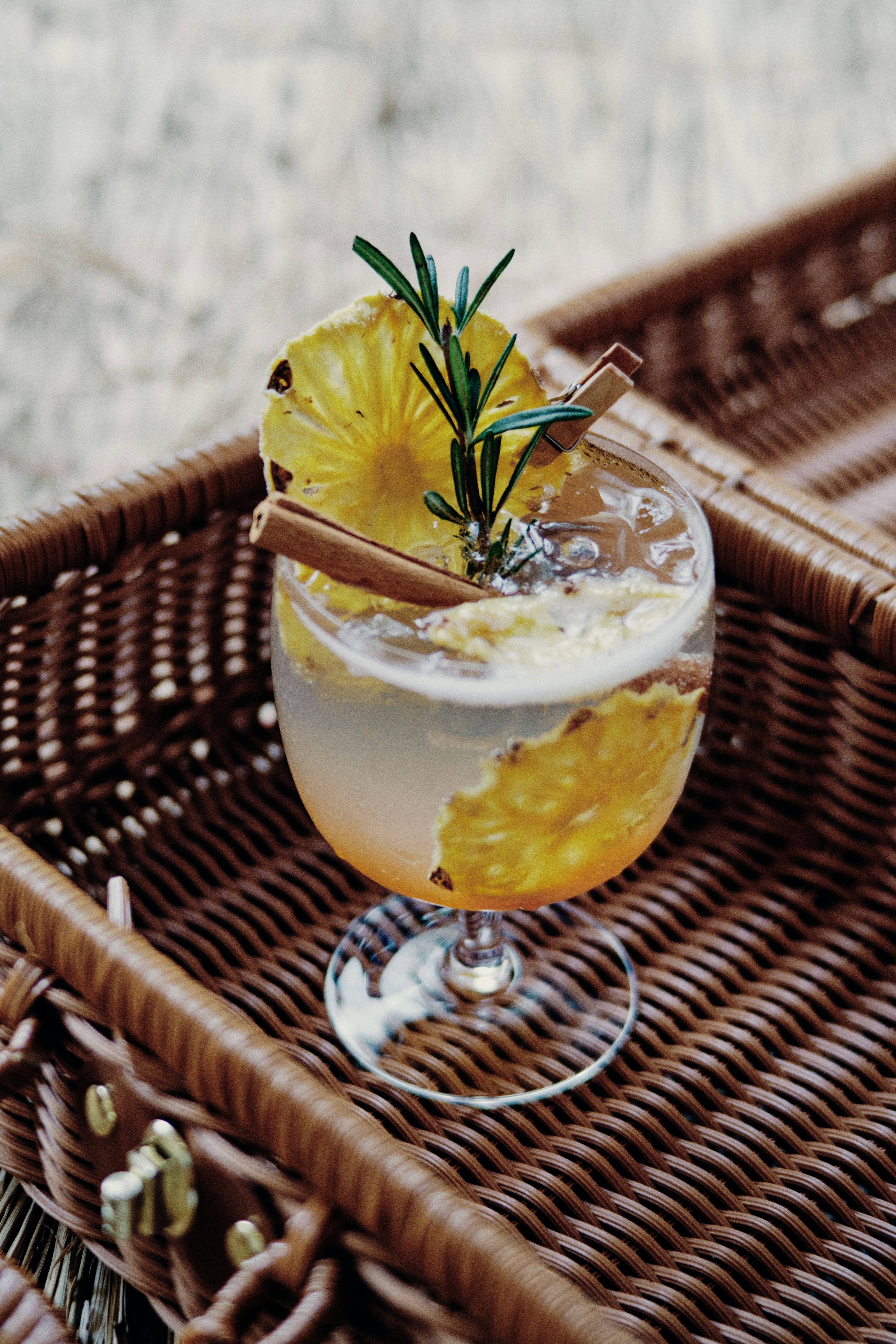 Citrus Spritz on a Wicker Stage: Pineapple, Rosemary, and Cinnamon